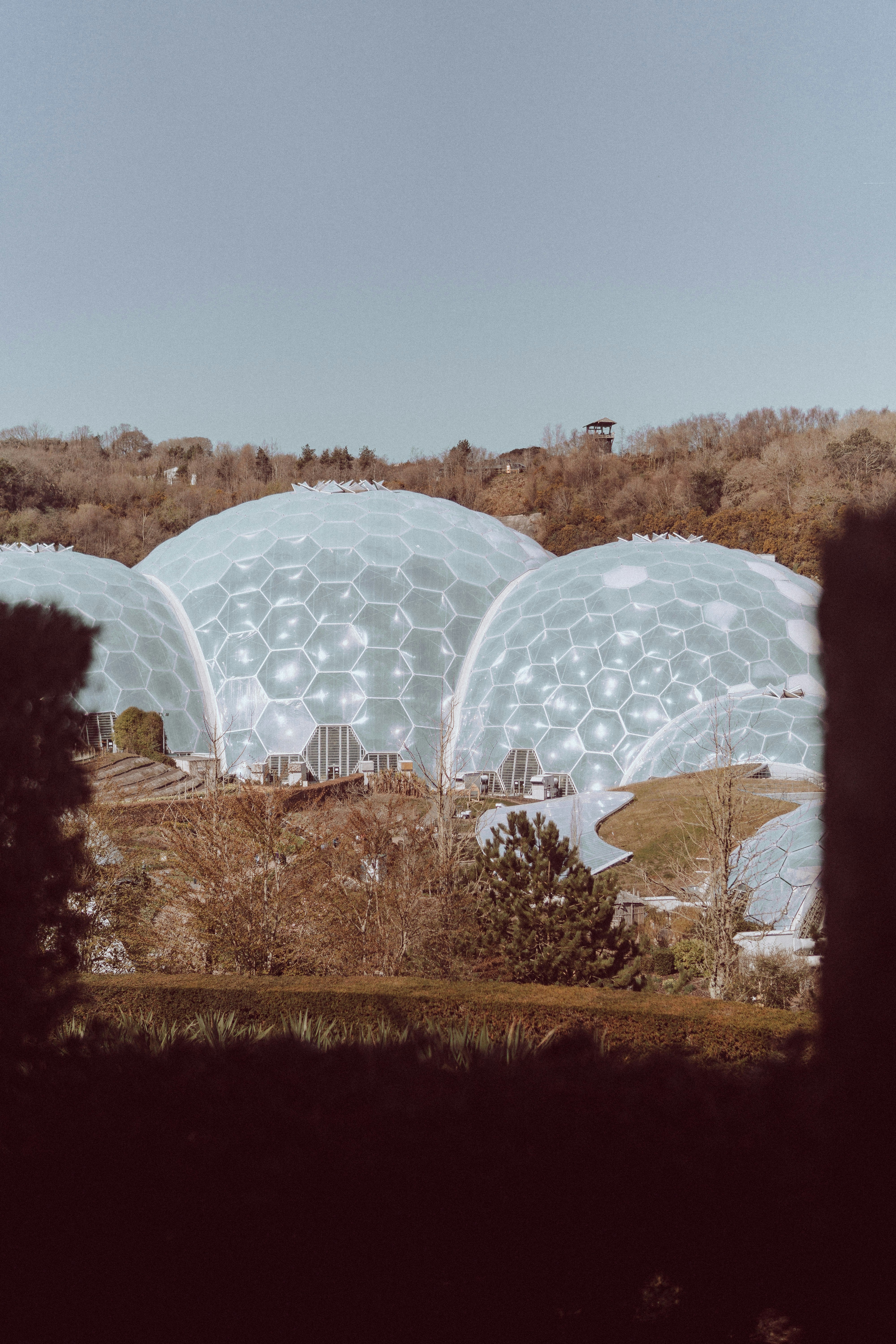 a couple of white domes sitting on top of a hill
