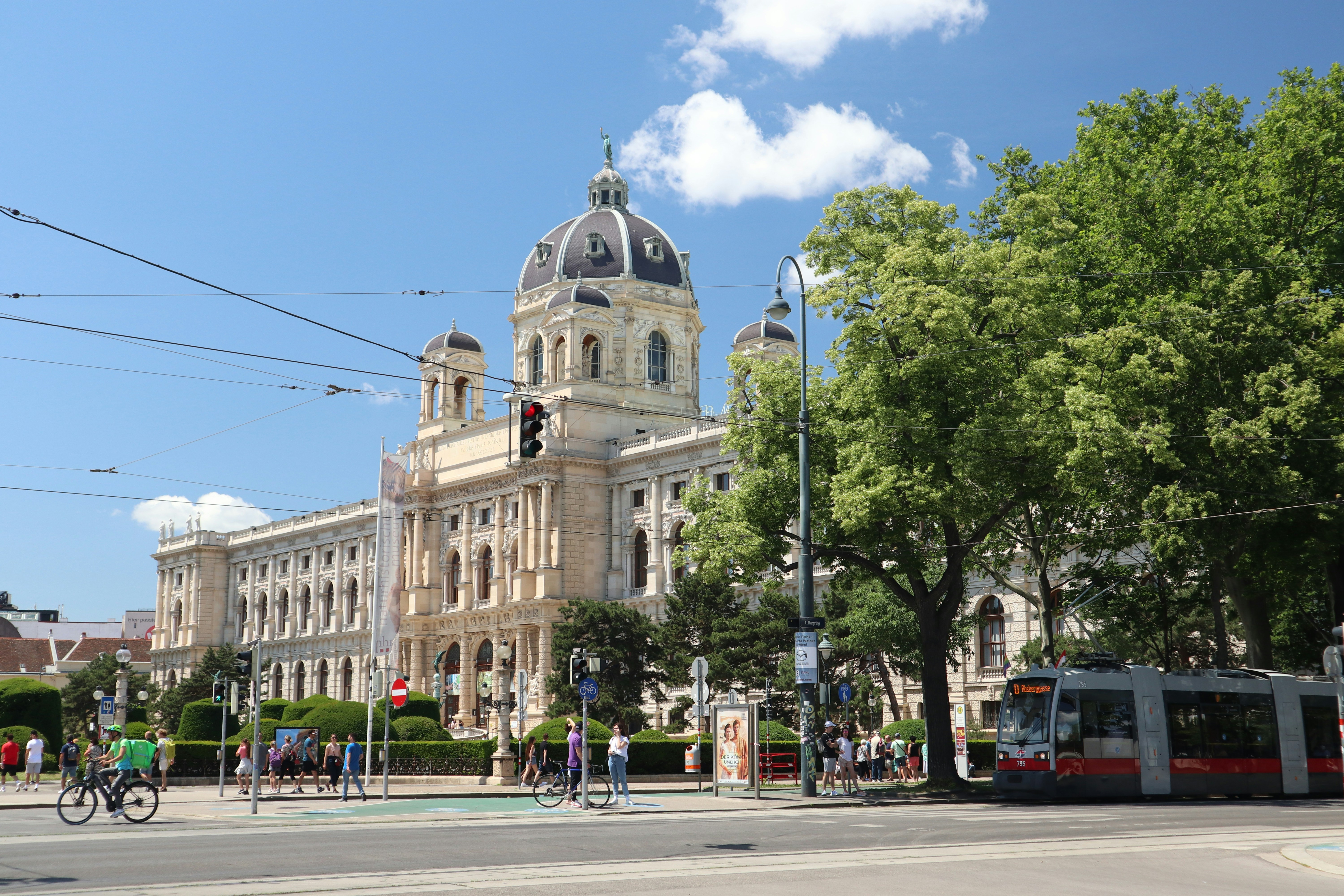 Sunlit Dome and Streetcar: A Historic Heartline Framed by Trams and Trees