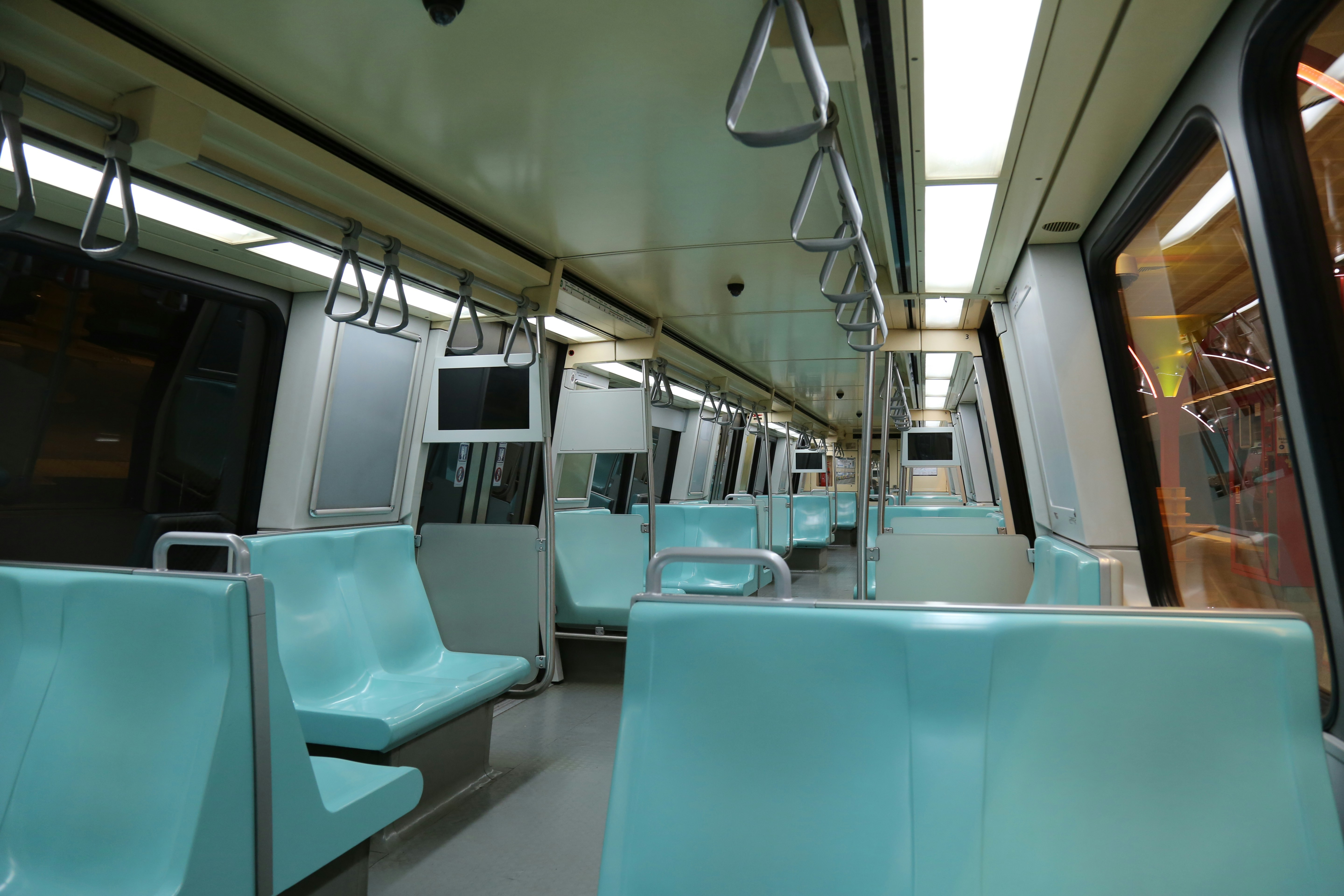 Teal Silence: The Quiet Aisle of an Empty Subway Car