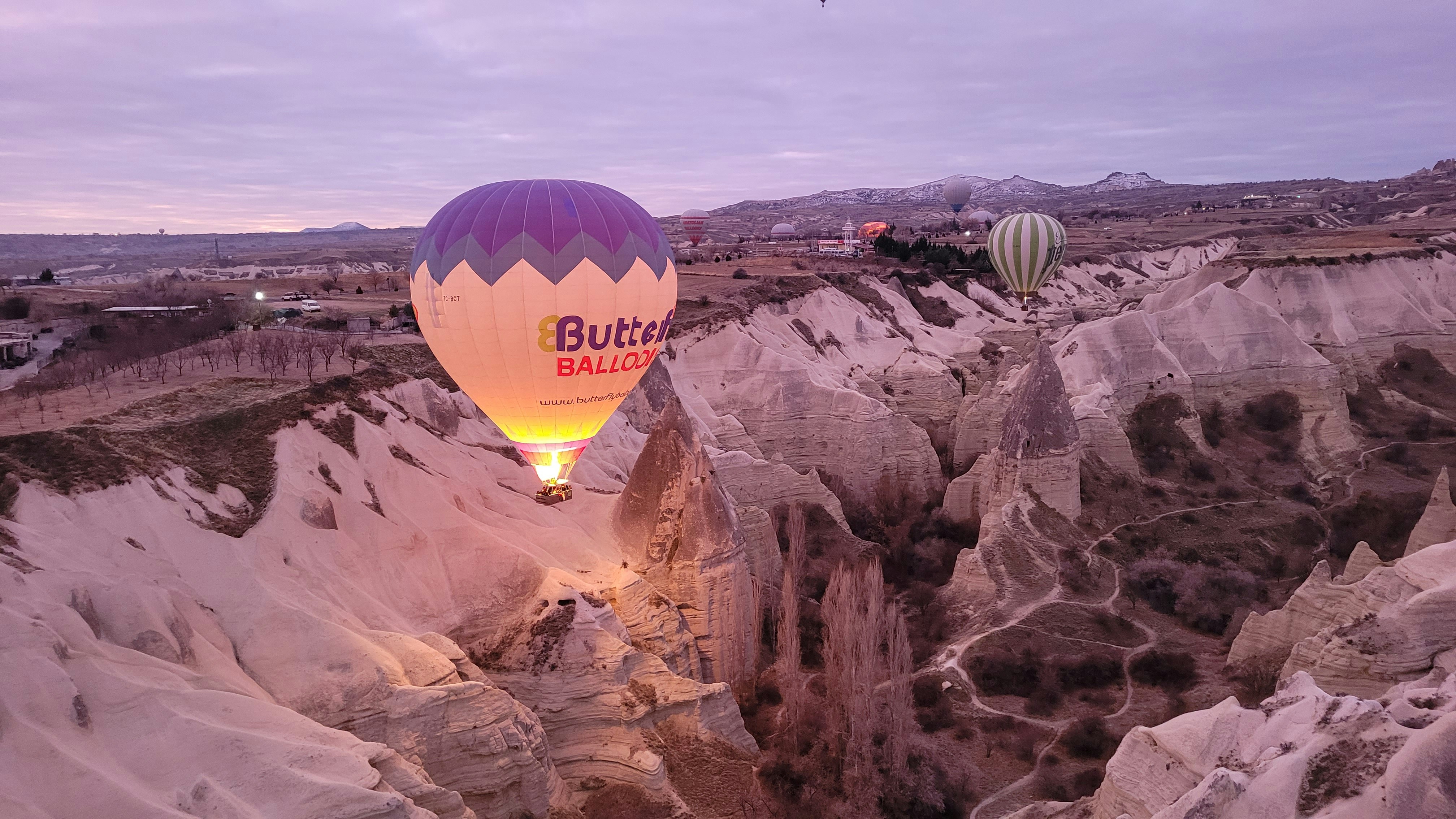 Balloon Over Wind-Sculpted Valleys at Twilight