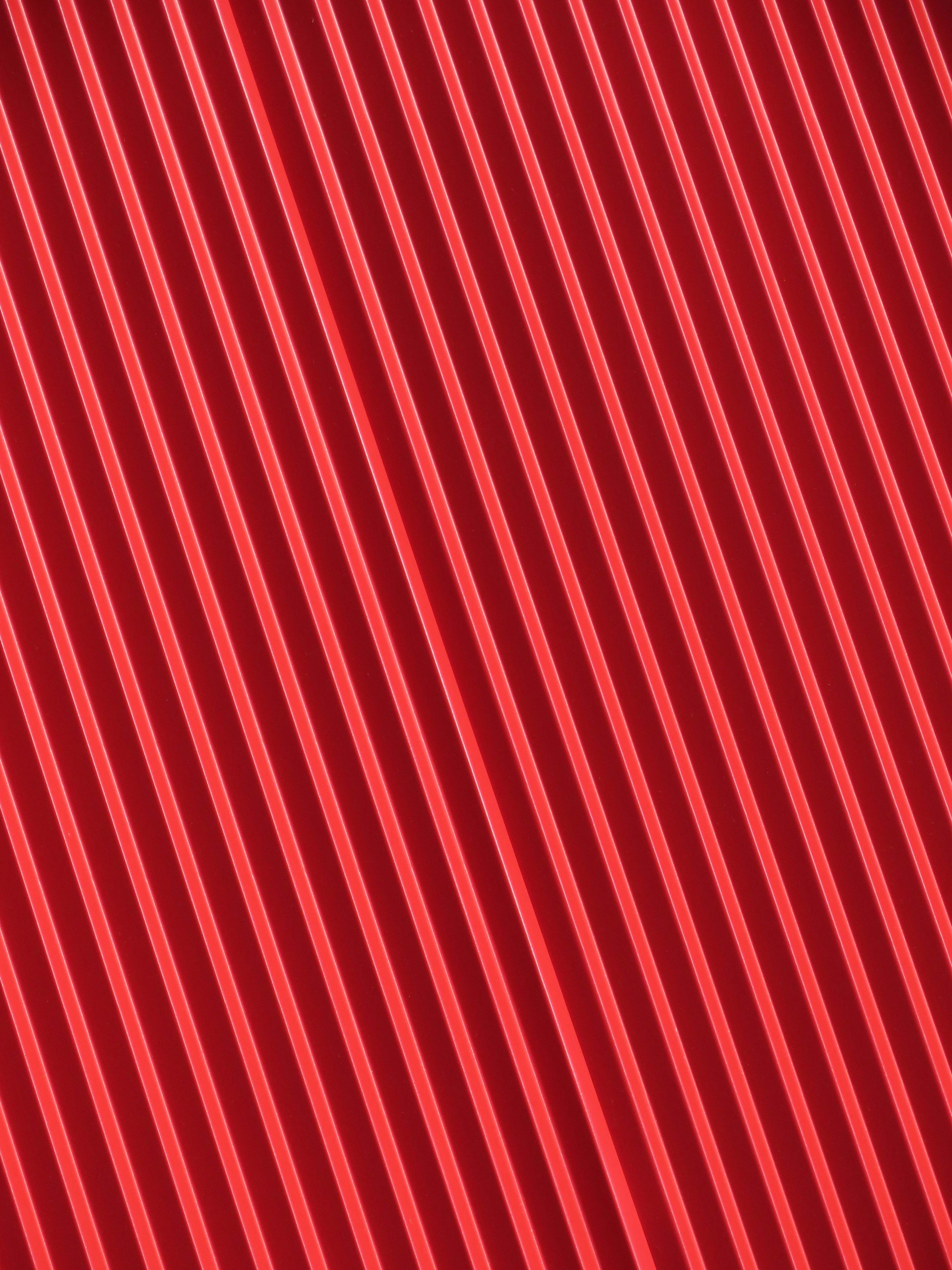 Abstract pattern of red parallel lines creating a dynamic visual rhythm.