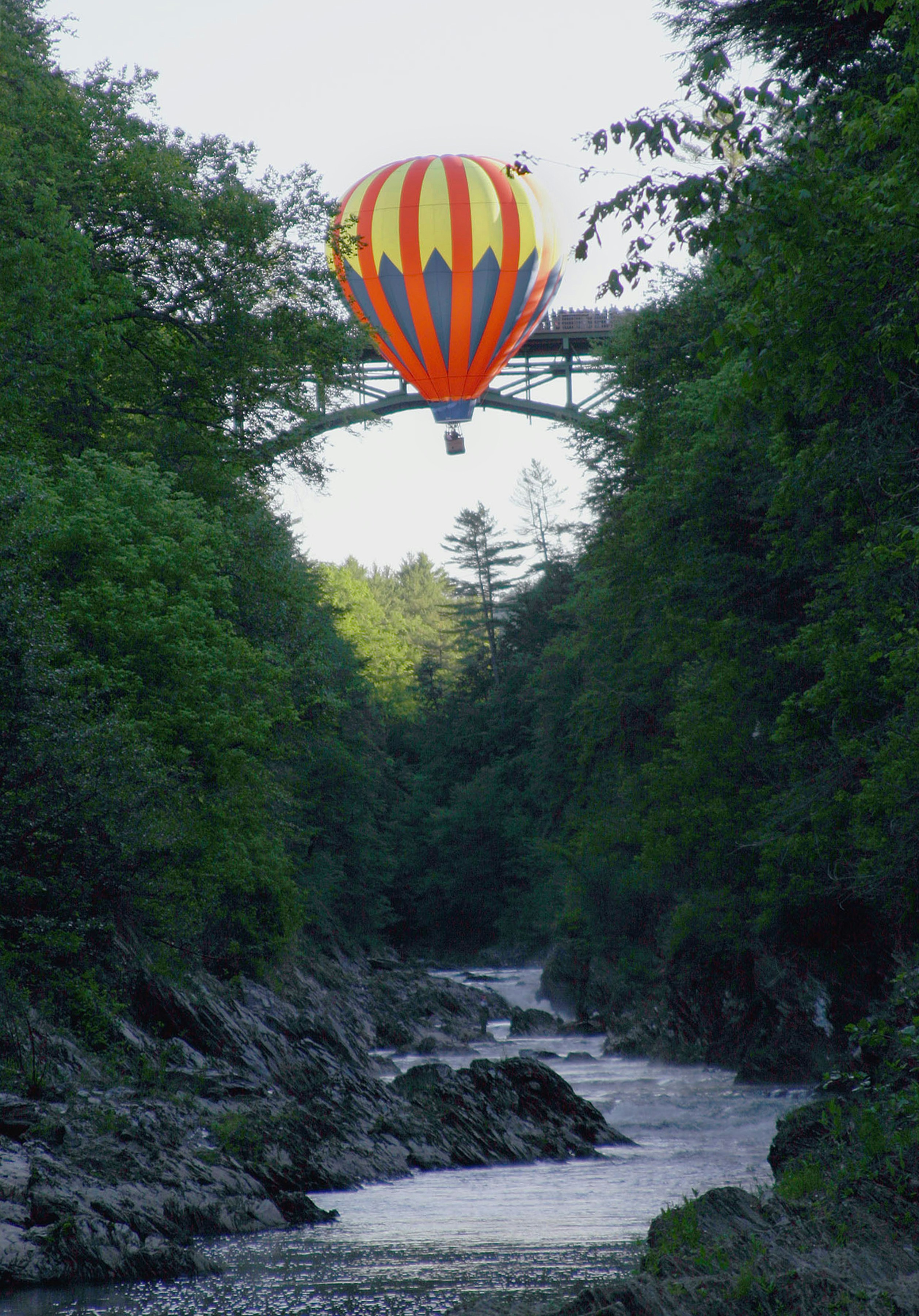Chromatic Balloon Crossing the Verdant River Gorge