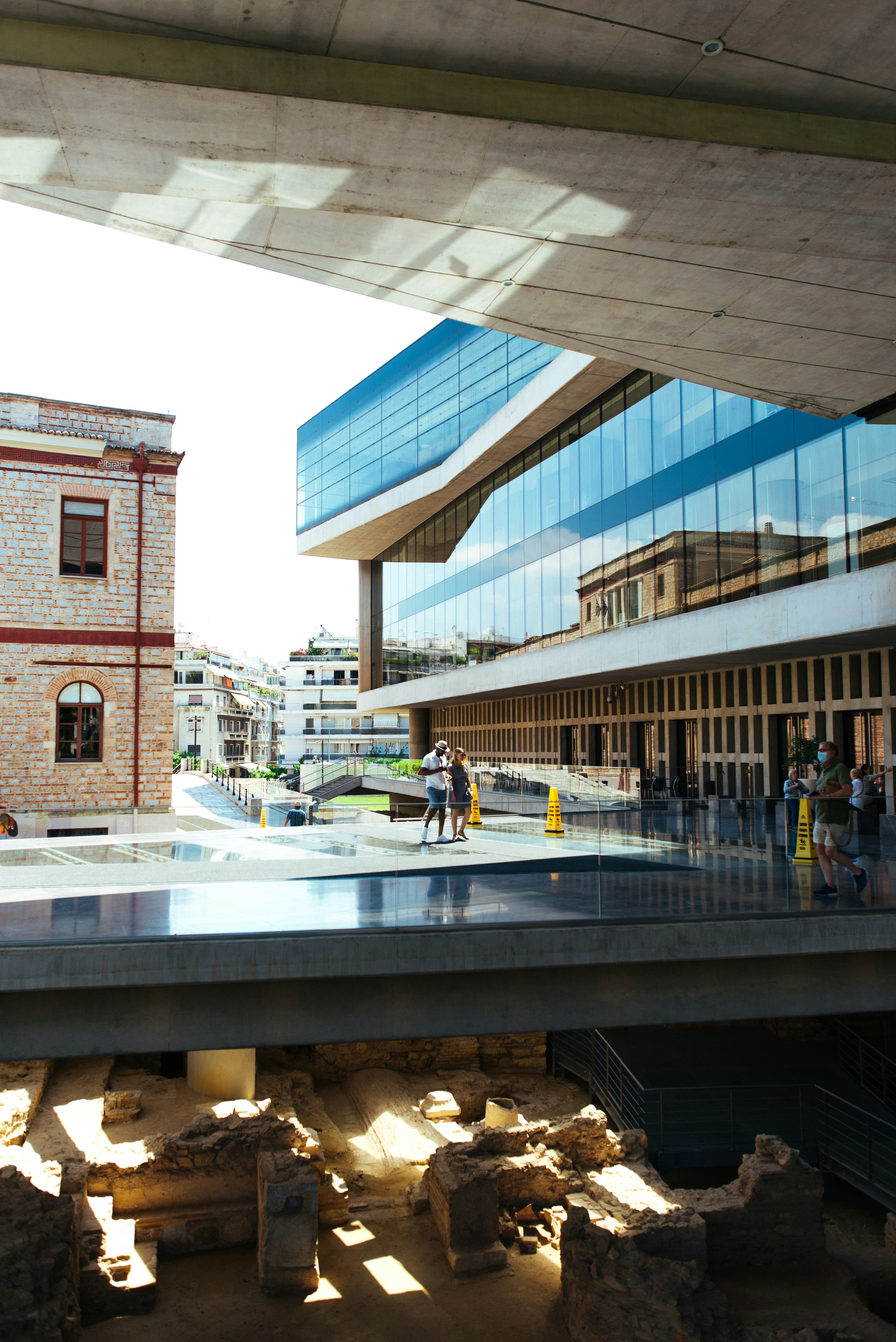Bridge Between Eras: A Modern Glass Facade Over Ancient Ruins