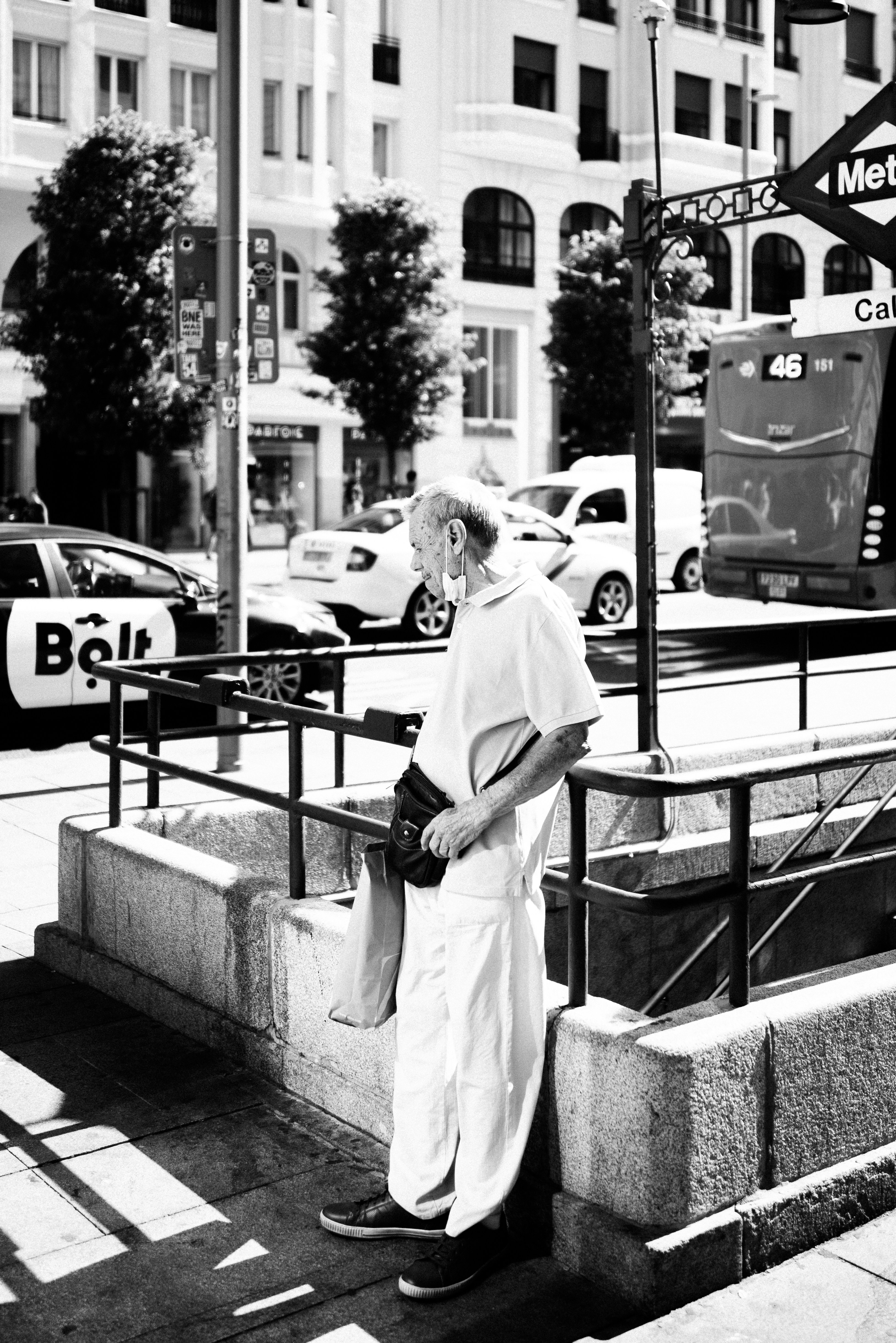 White-Clad Pause at the City Transit Edge