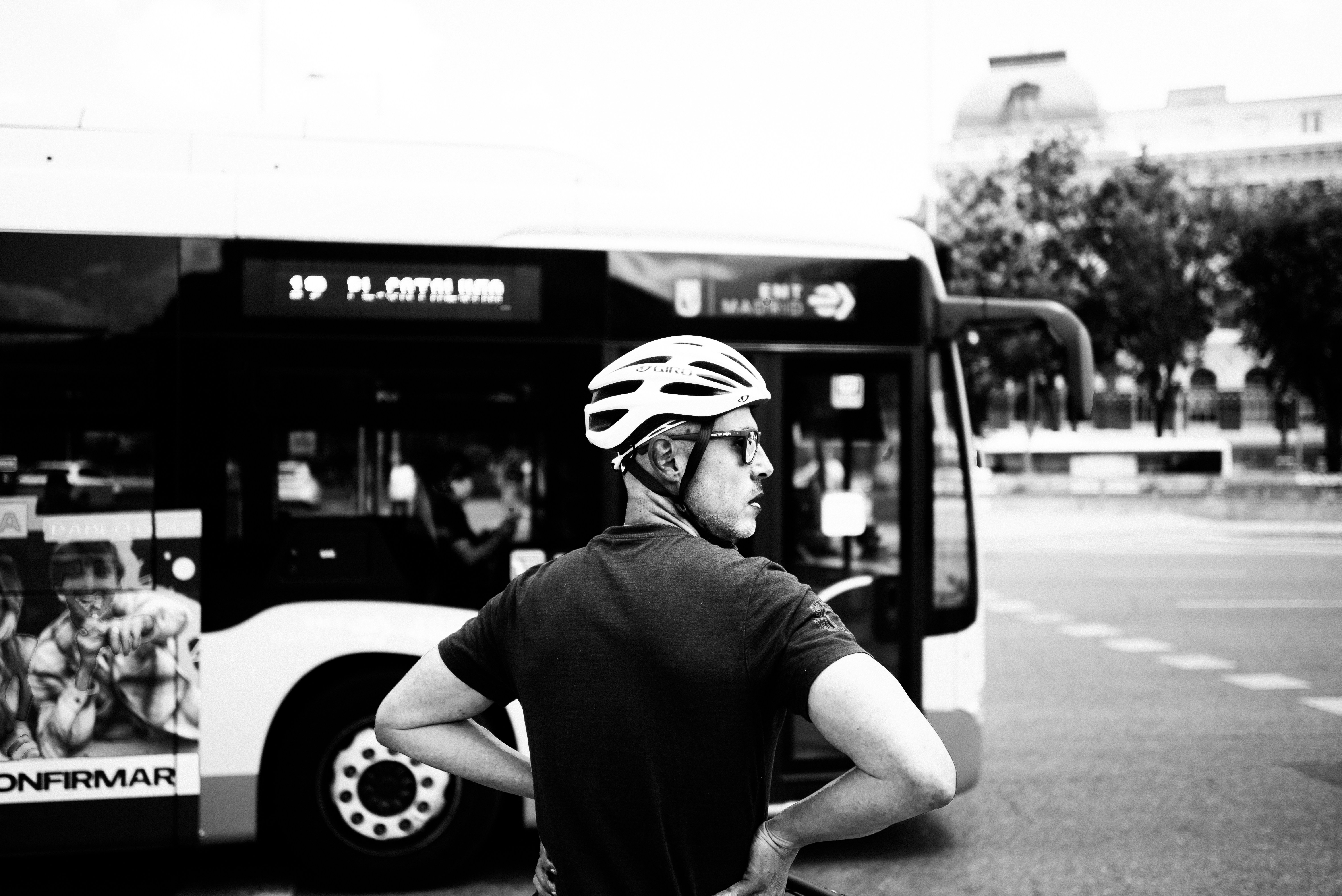 A person wearing a helmet and standing next to a bus photo – Free Man ...