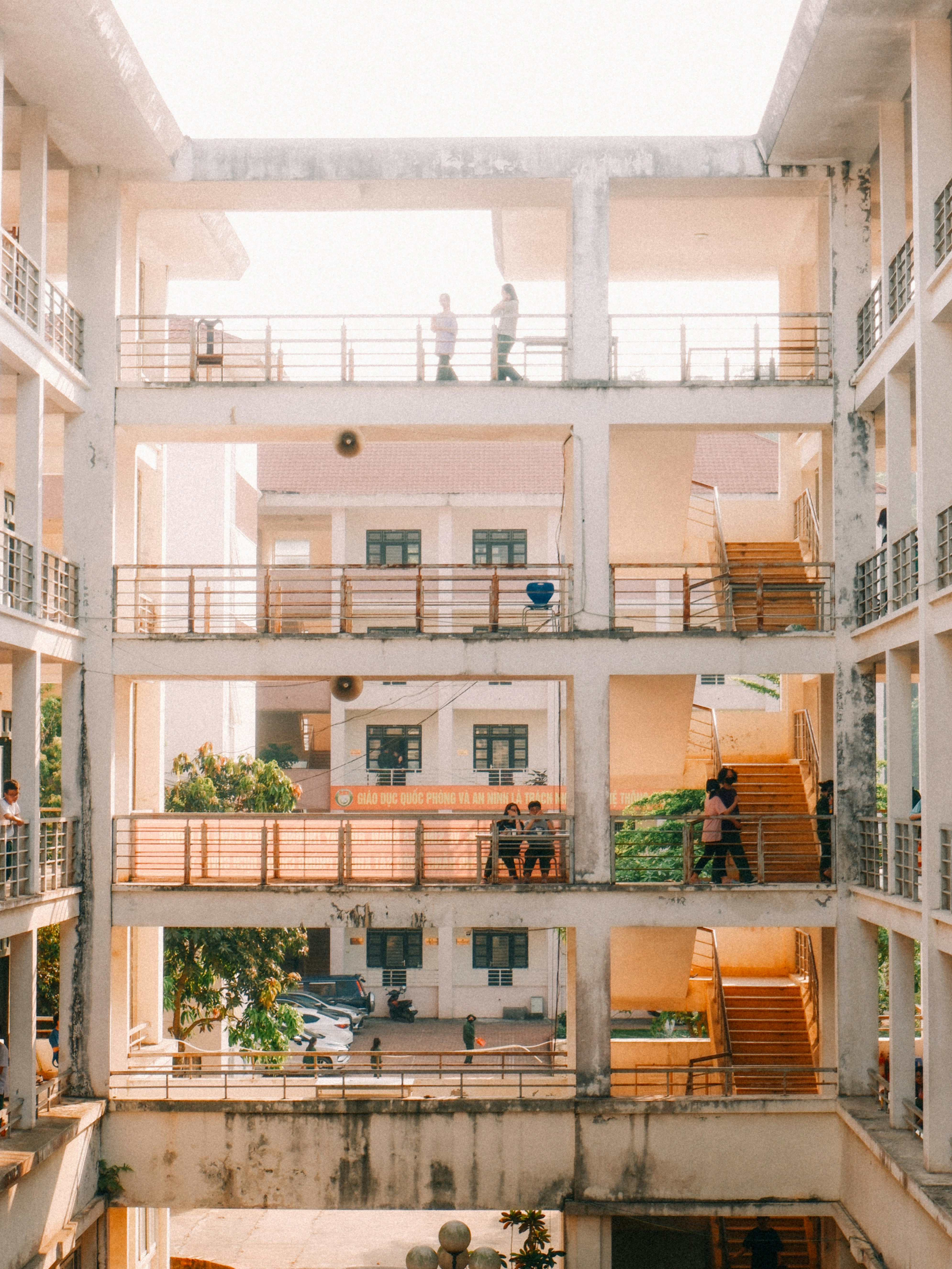 A building with balconies and a person standing on the balcony photo ...
