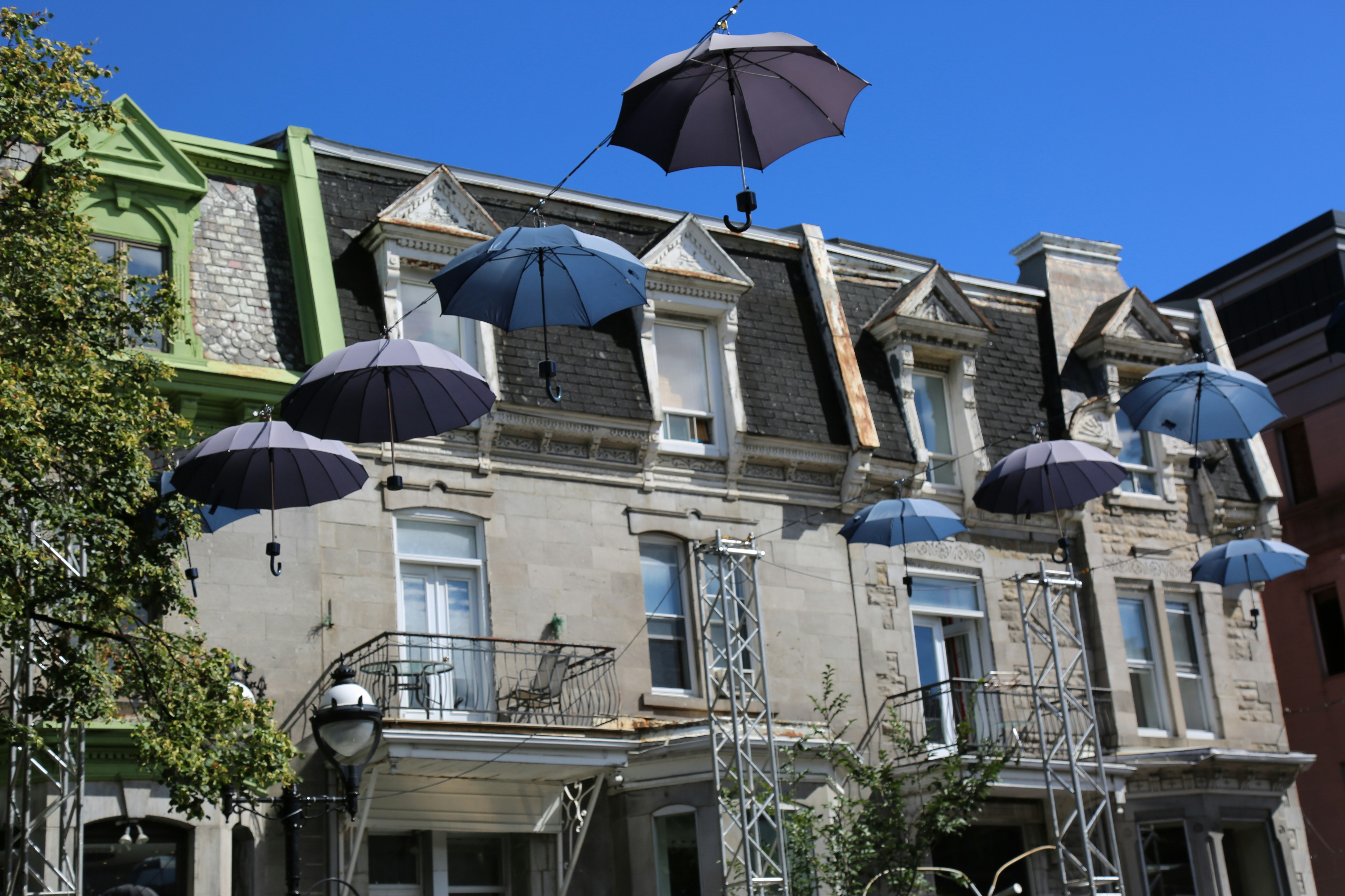 Several umbrellas are from a building photo – Free Canada Image on Unsplash