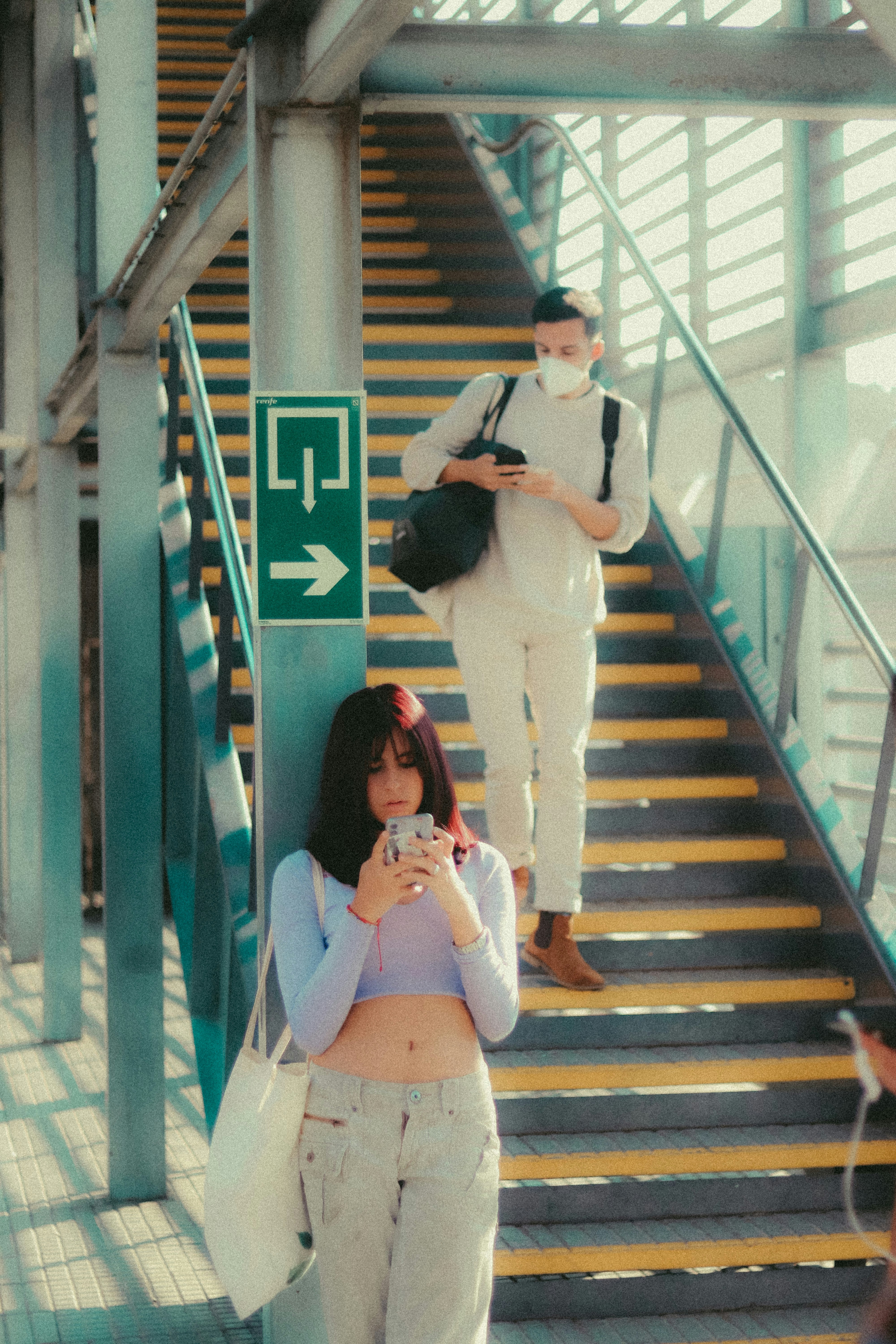A woman taking a picture of a man on a staircase photo – Free Human ...