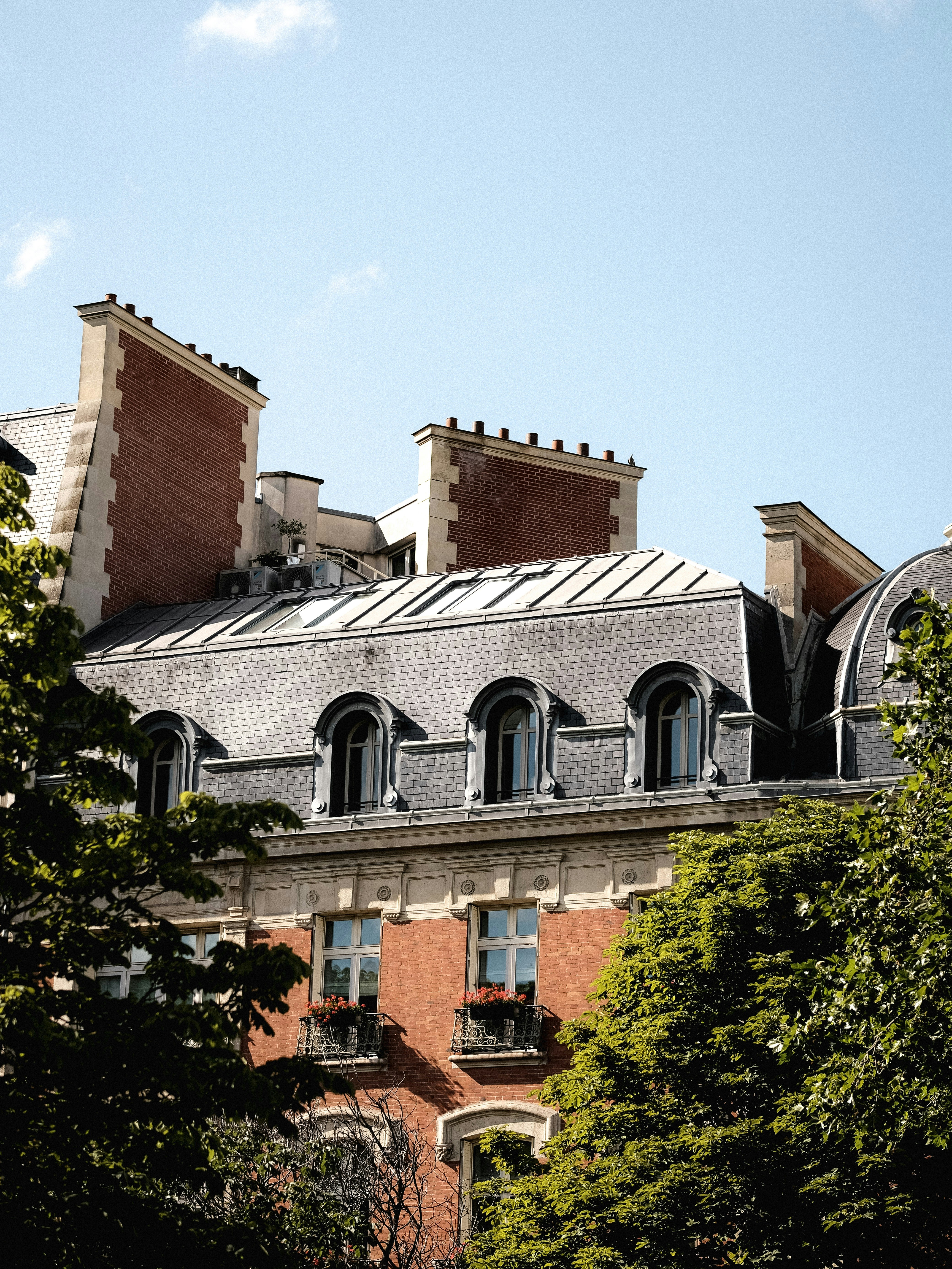 A large brick building with a chimney photo – Free Paris Image on Unsplash