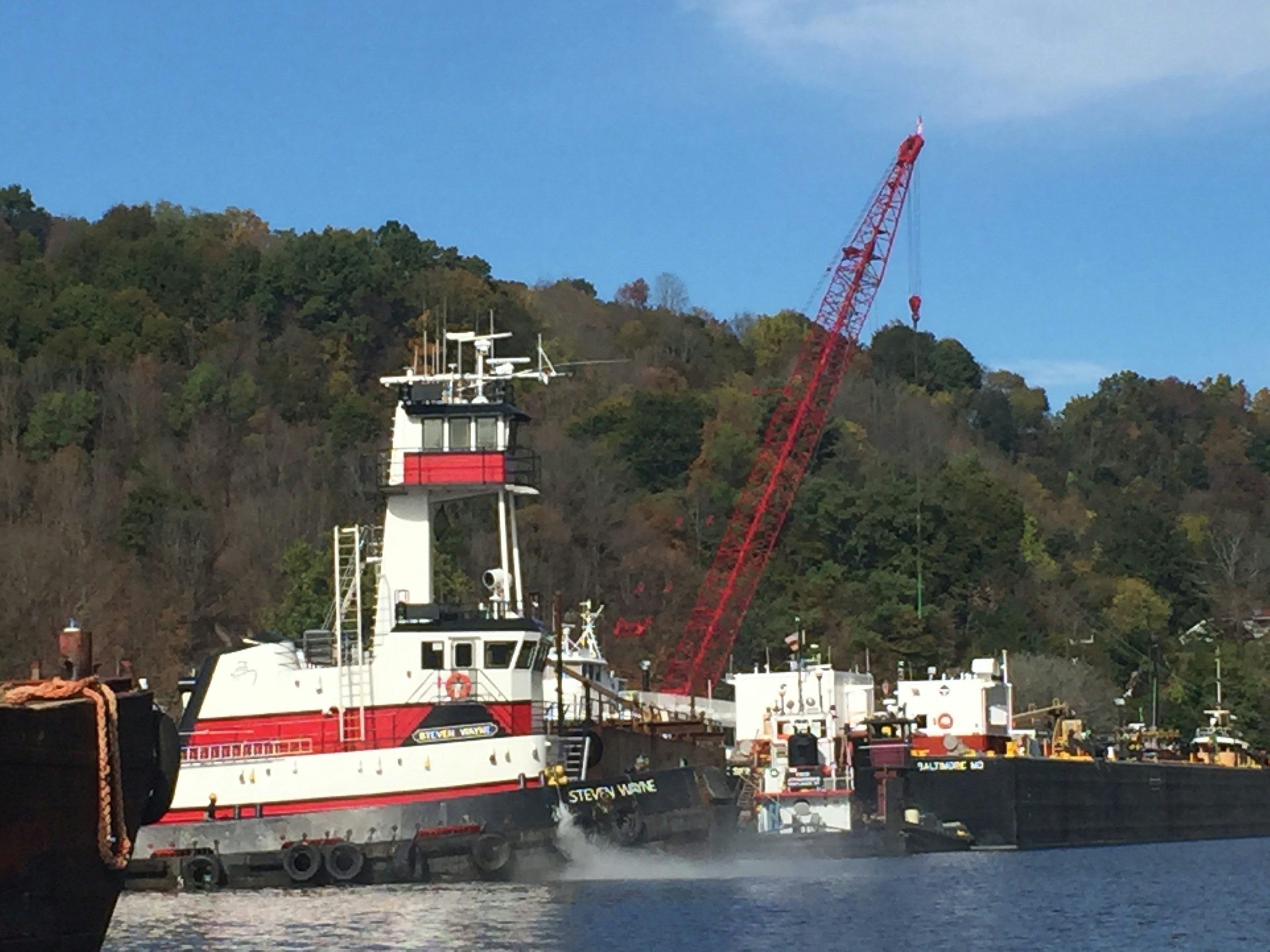 Tow Harbor at Dusk: Tugboats and Cranes in a Busy Terminal