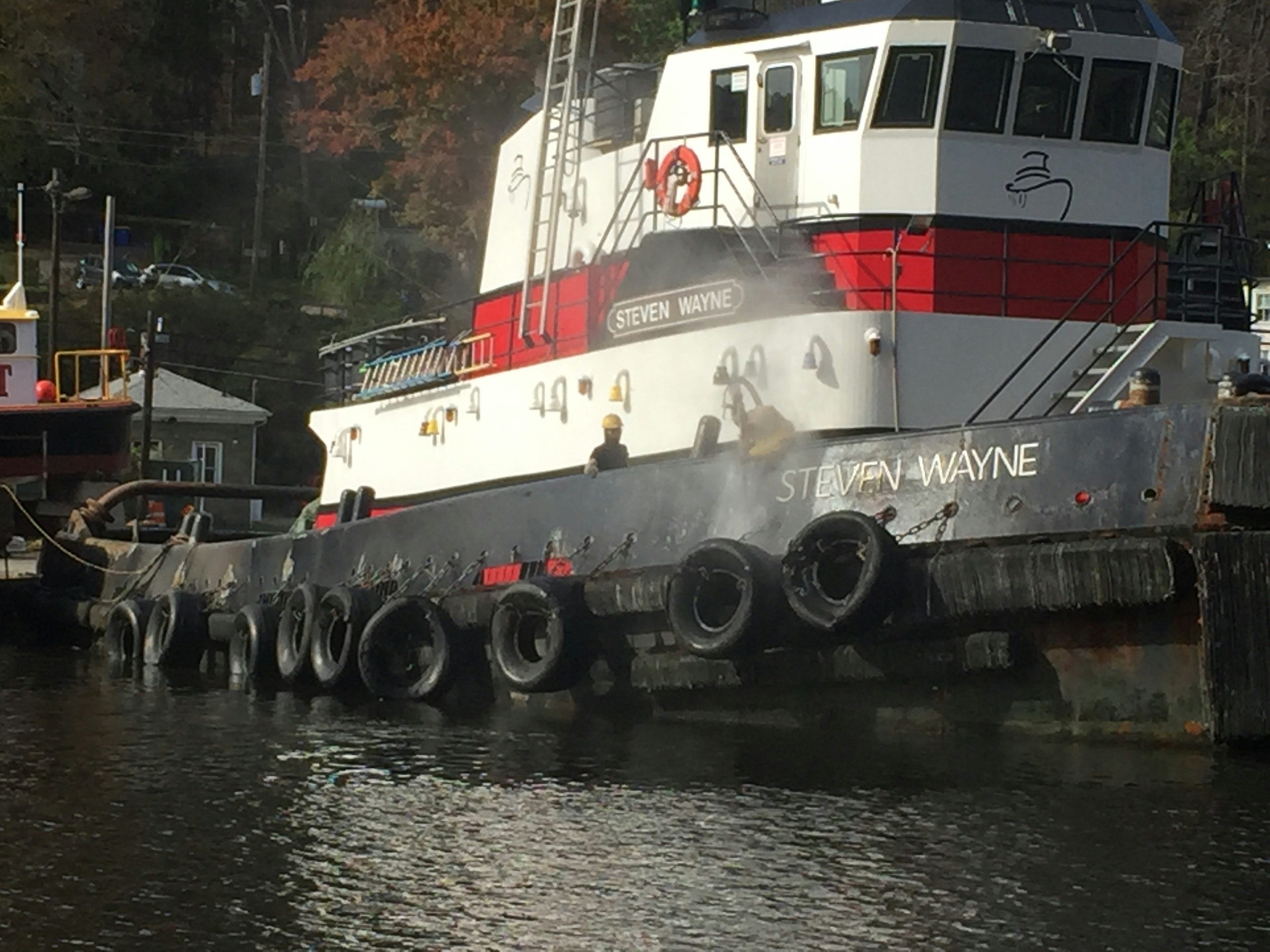 Steven Wayne: A Weathered Tug Lounges at the Riverside Dock
