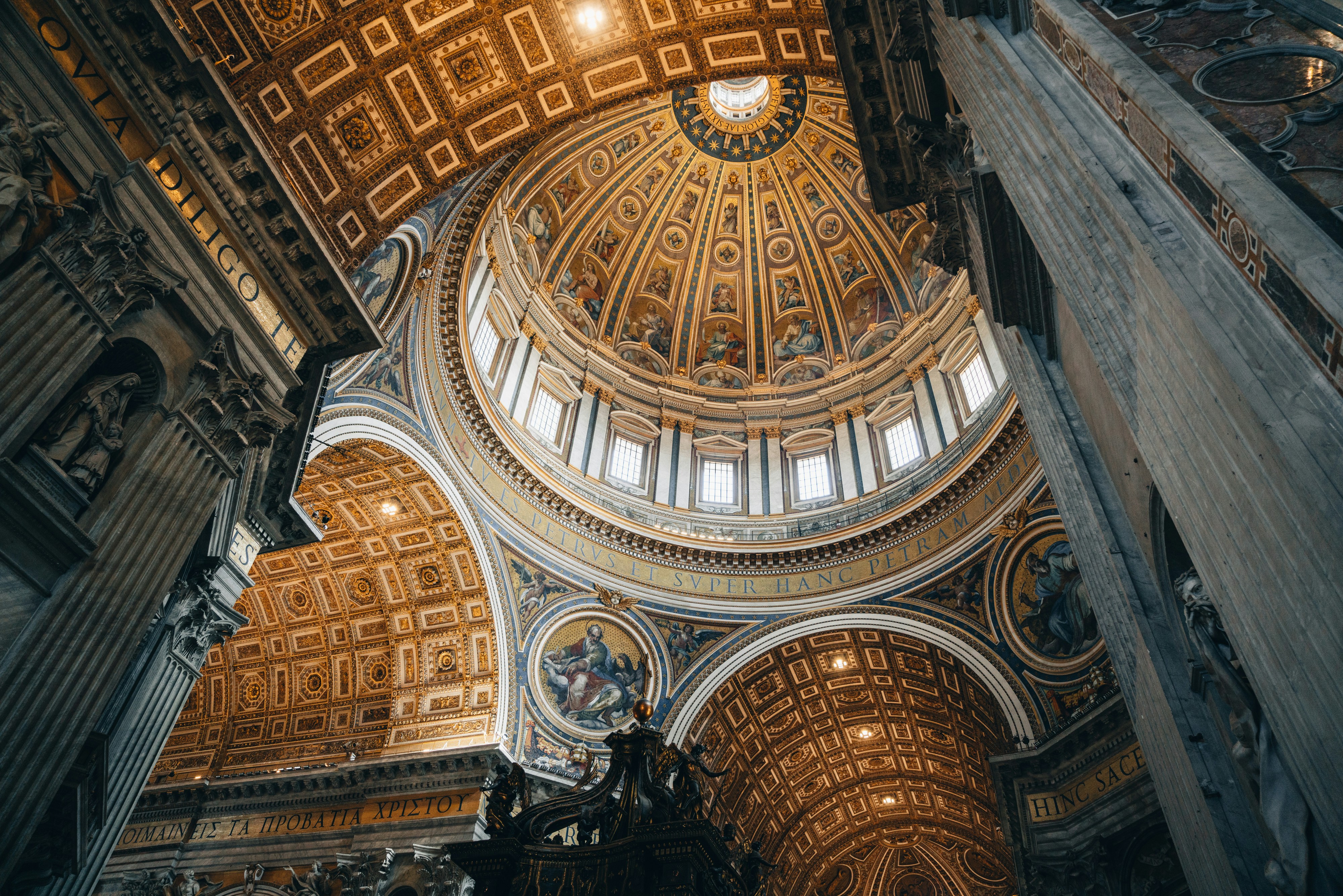 A domed ceiling with arched windows with St. Peter's Basilica in the ...