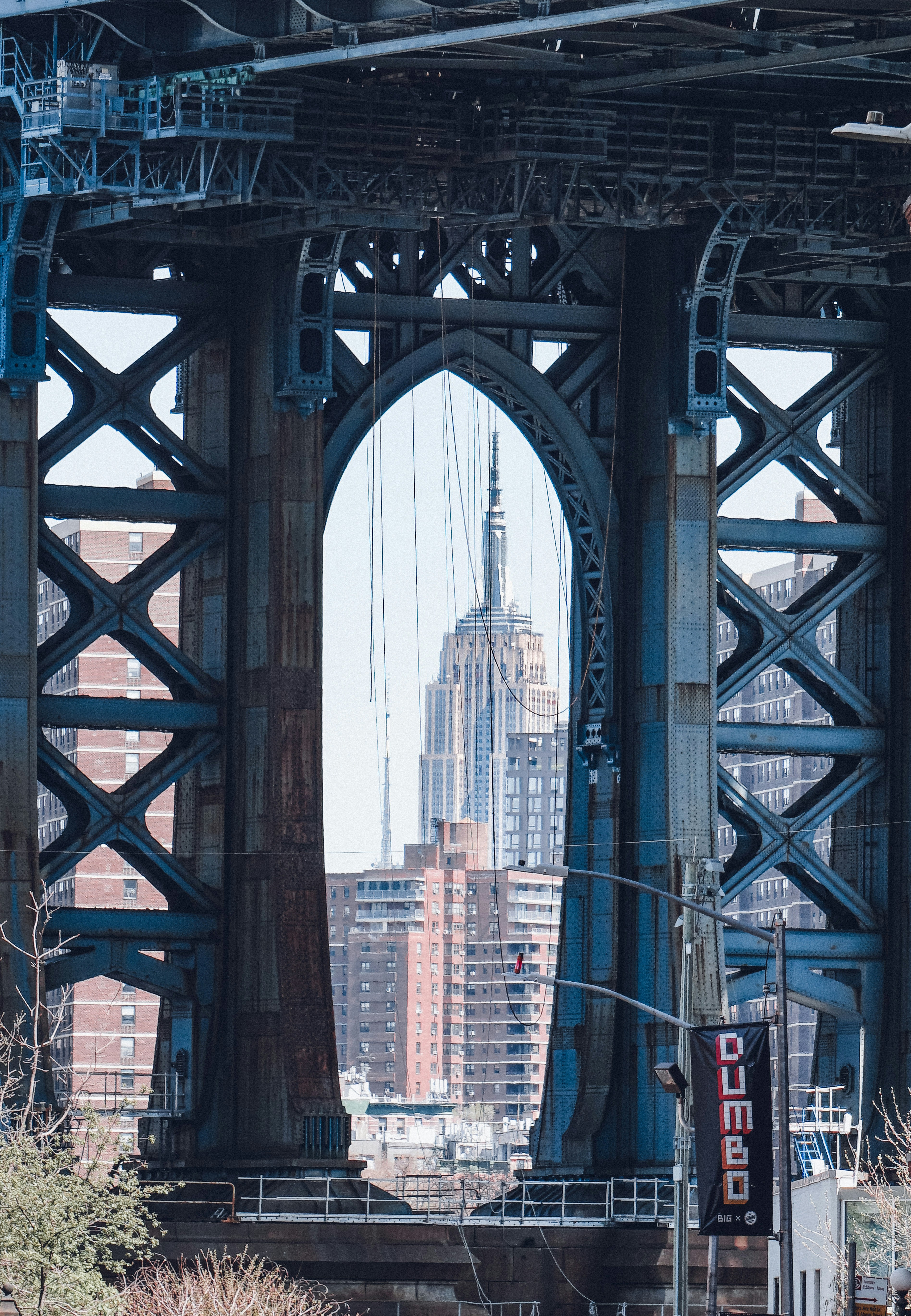 Arched Frame, City Crown: Empire State Within the Bridge's Steel Lace