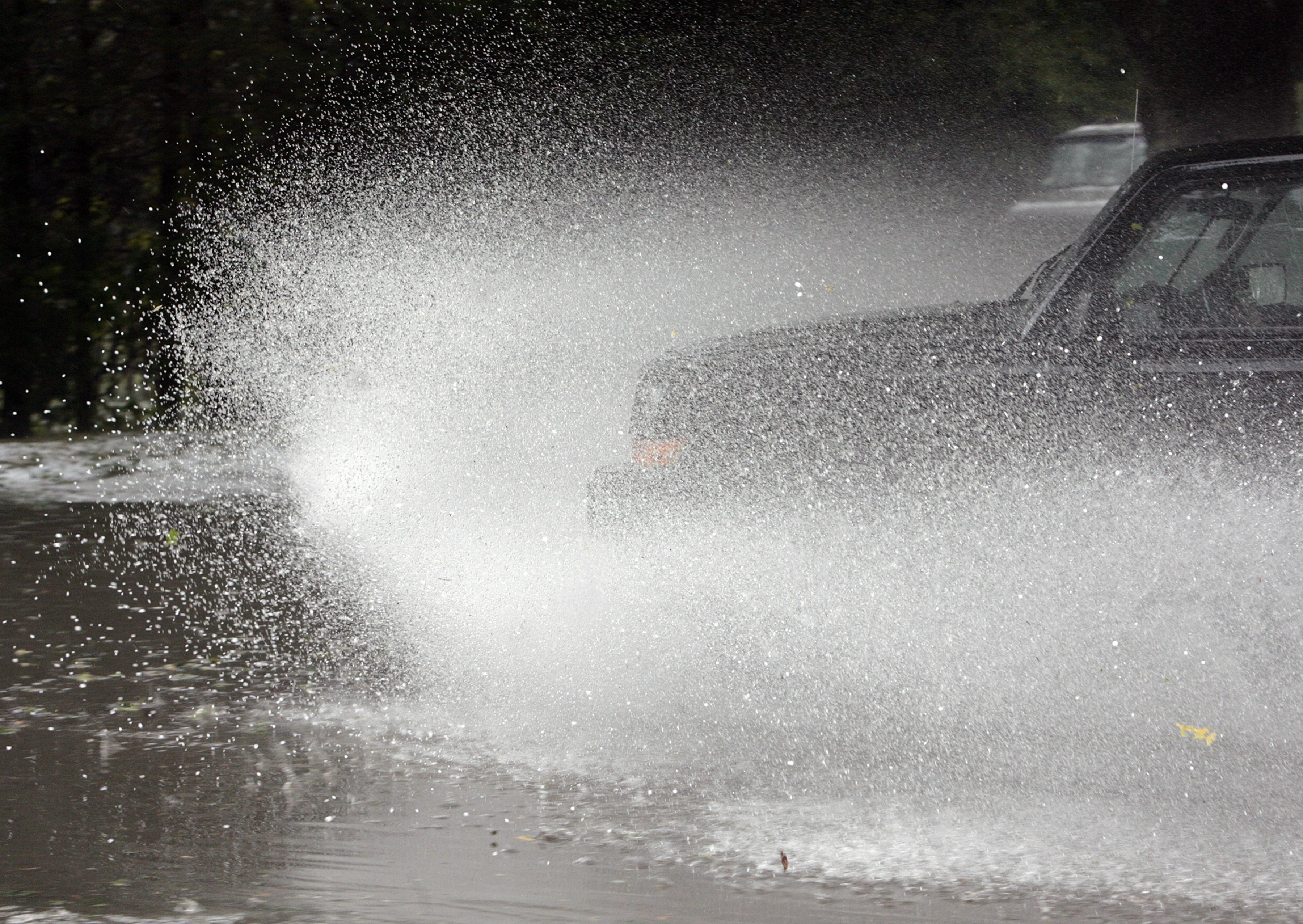 Urban Spray: A Sedan Pierces a Wall of Water
