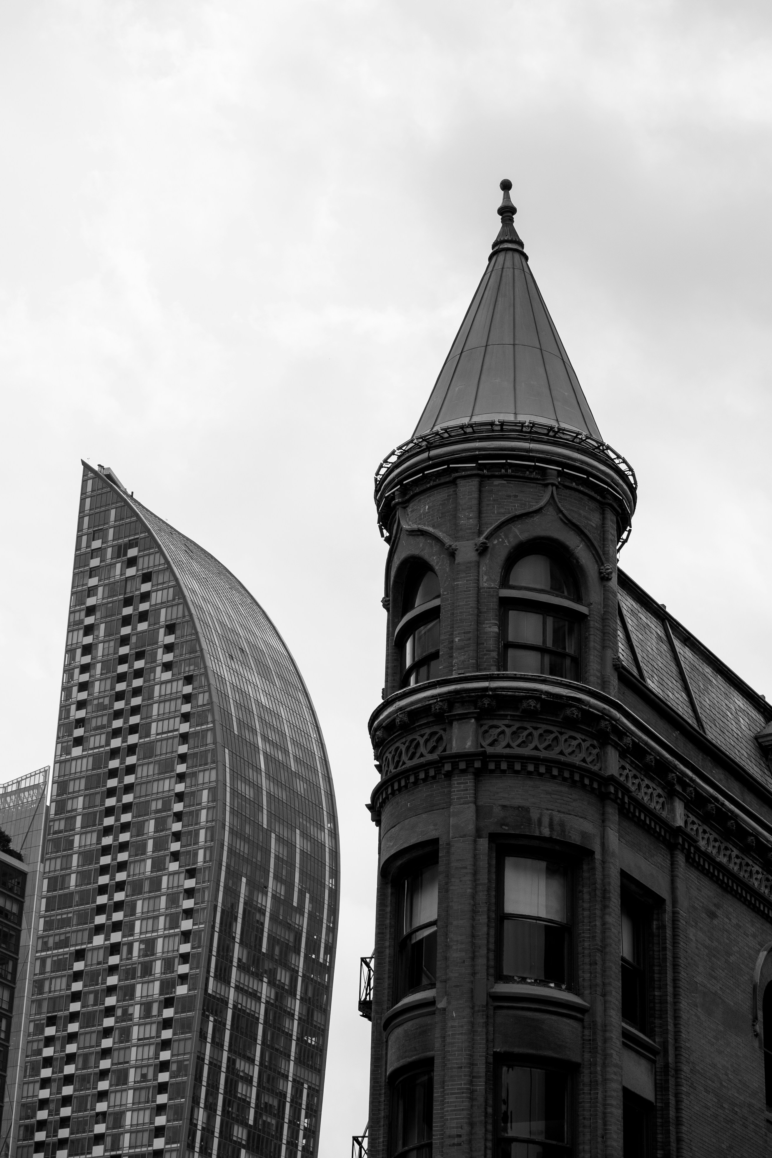 Brick Turret Meets the Glass Arc: A Monochrome Cityscape in Dialogue