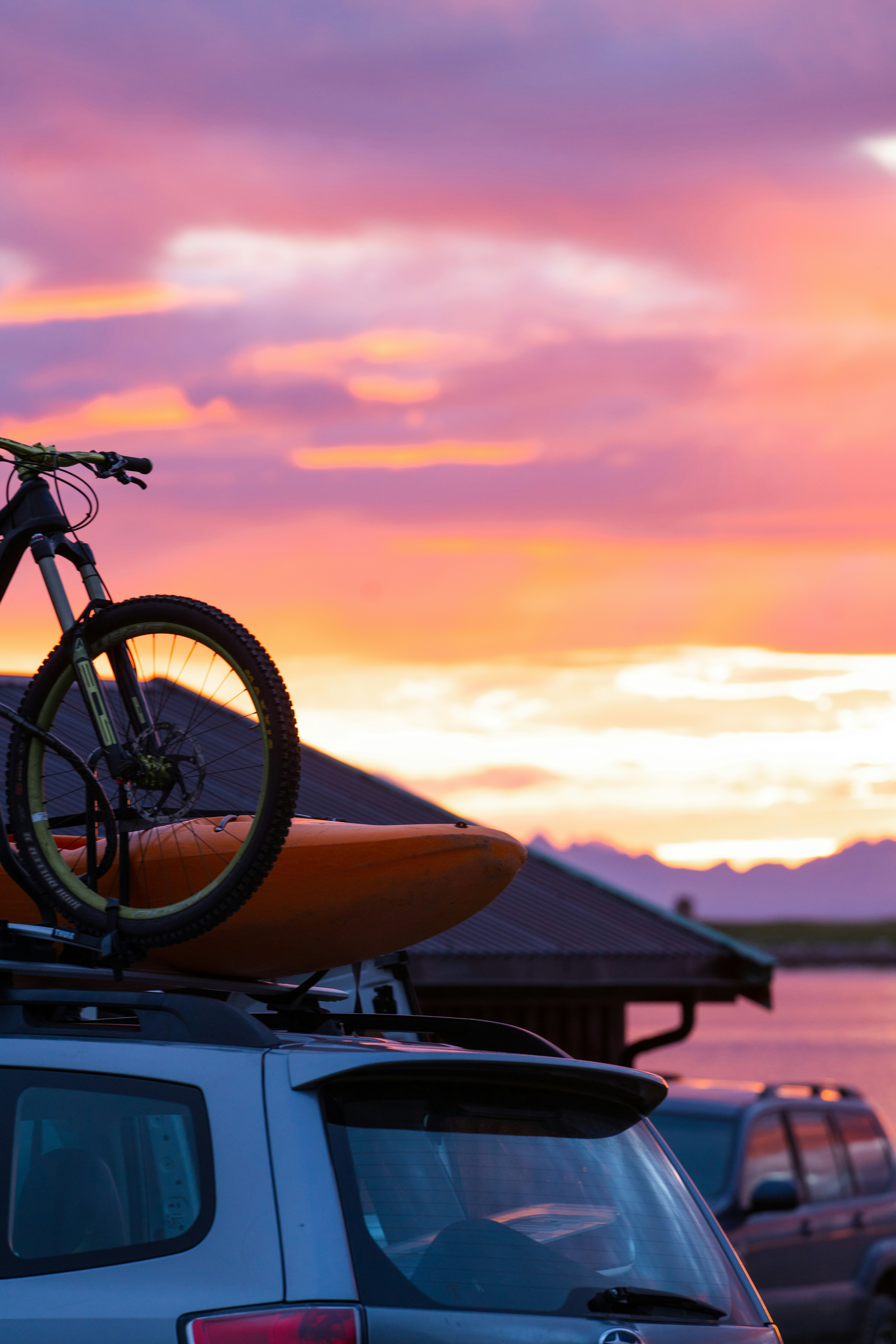 Ridge Sunset: Bike Rig Above the Quiet Hatchback