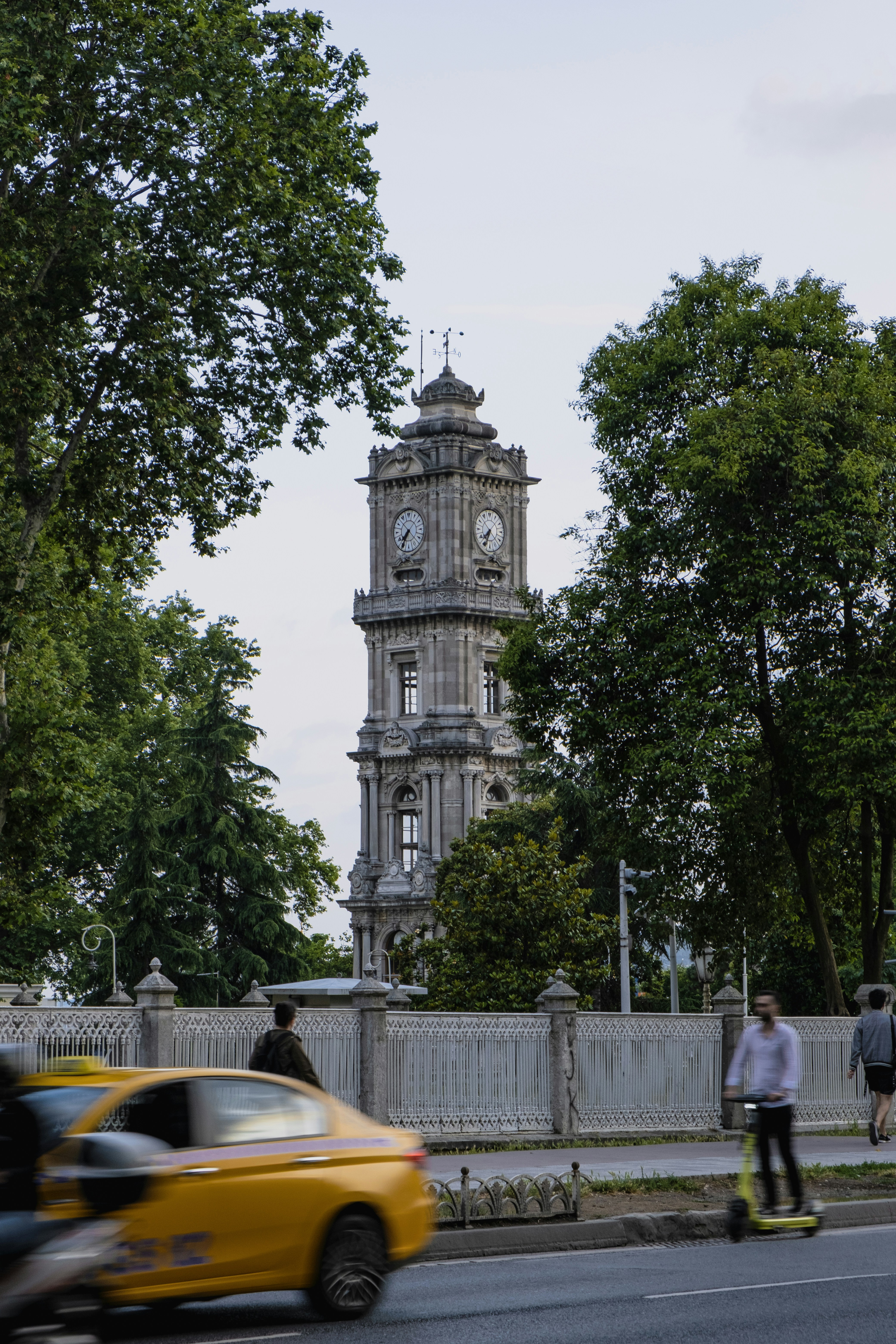 Clock Tower Between the Greens: City Street in Motion