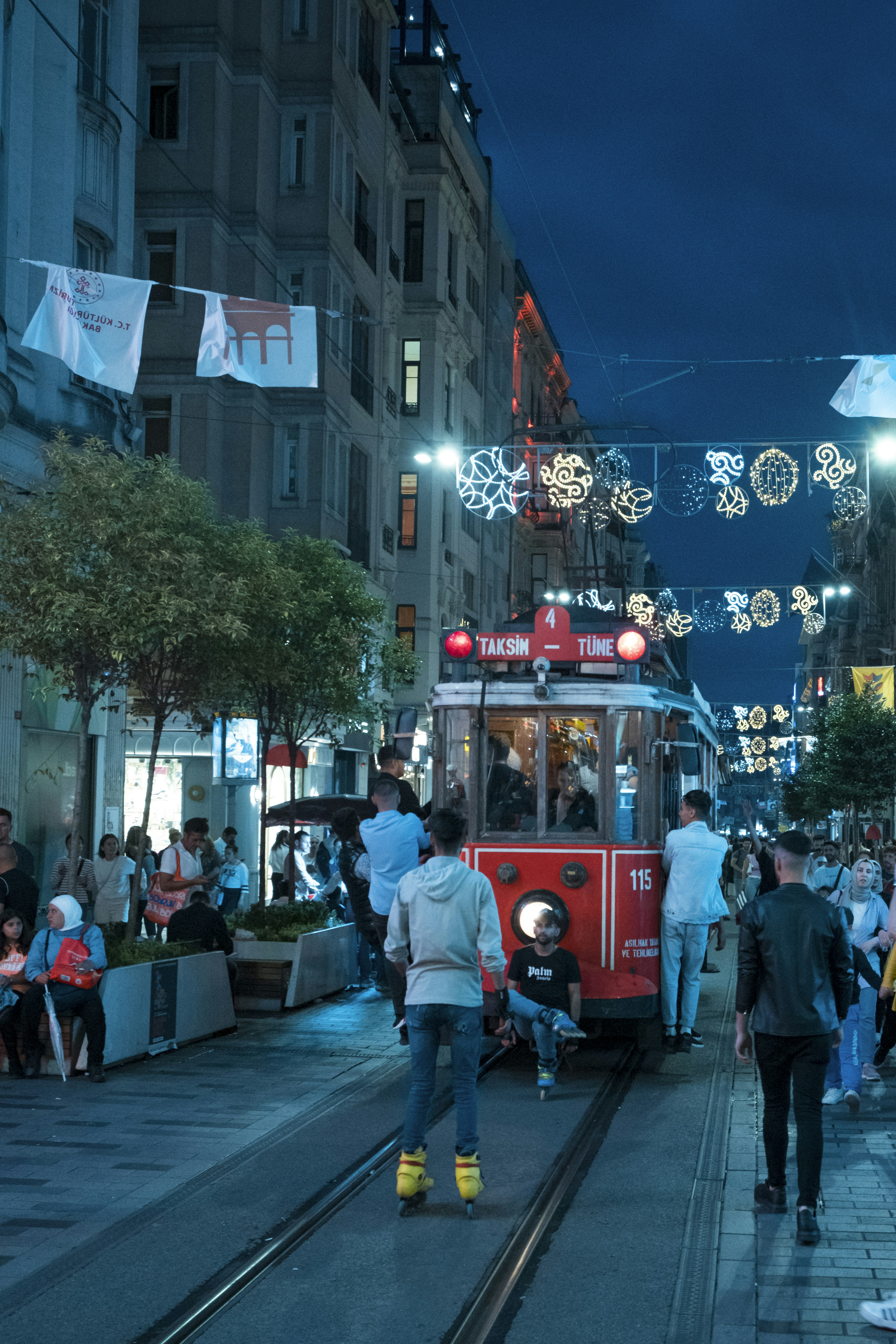 Red Tram Under Festive Night Lights on Istiklal Street