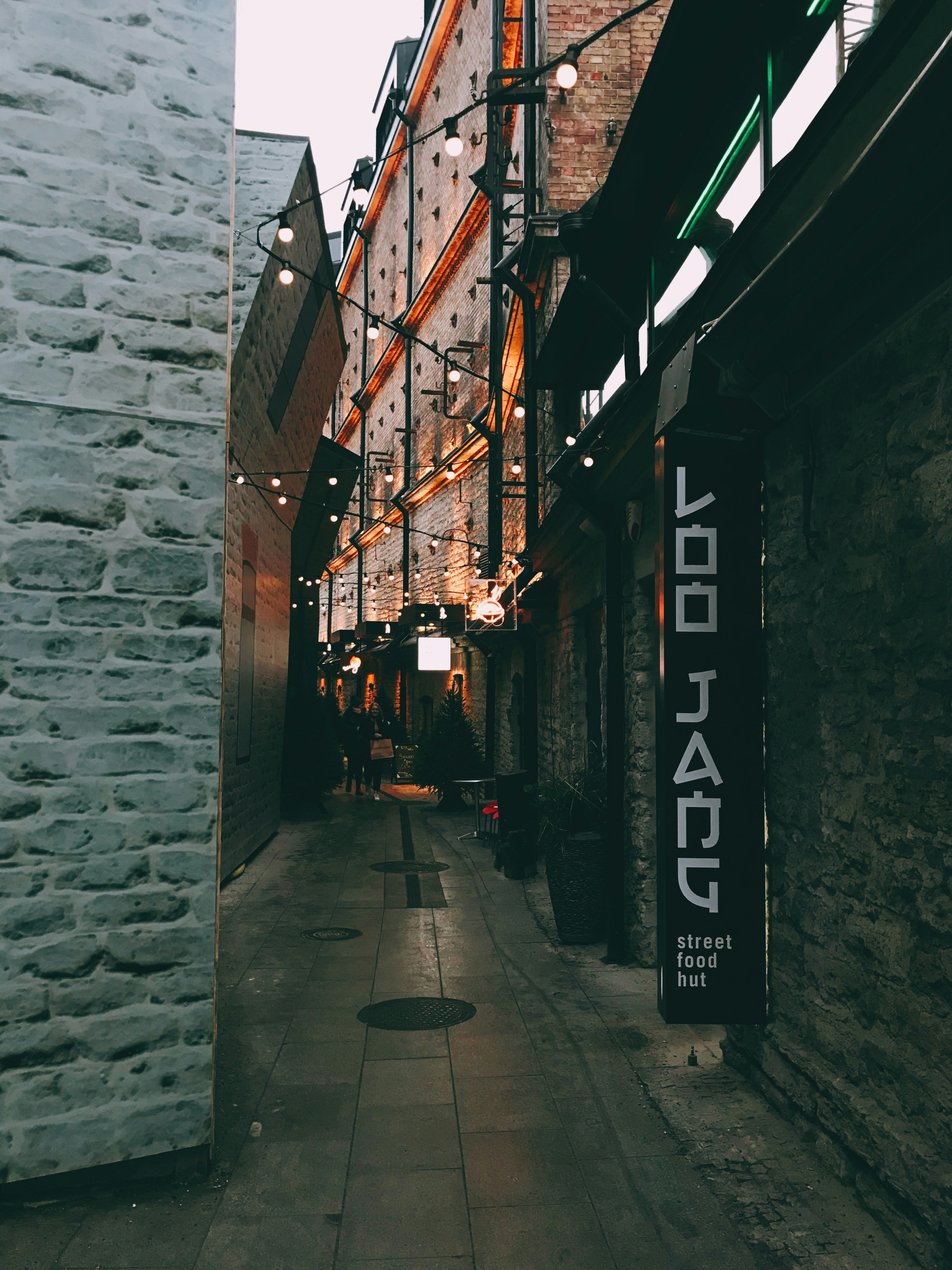 A narrow alley between two stone buildings photo – Free Tallinn Image ...