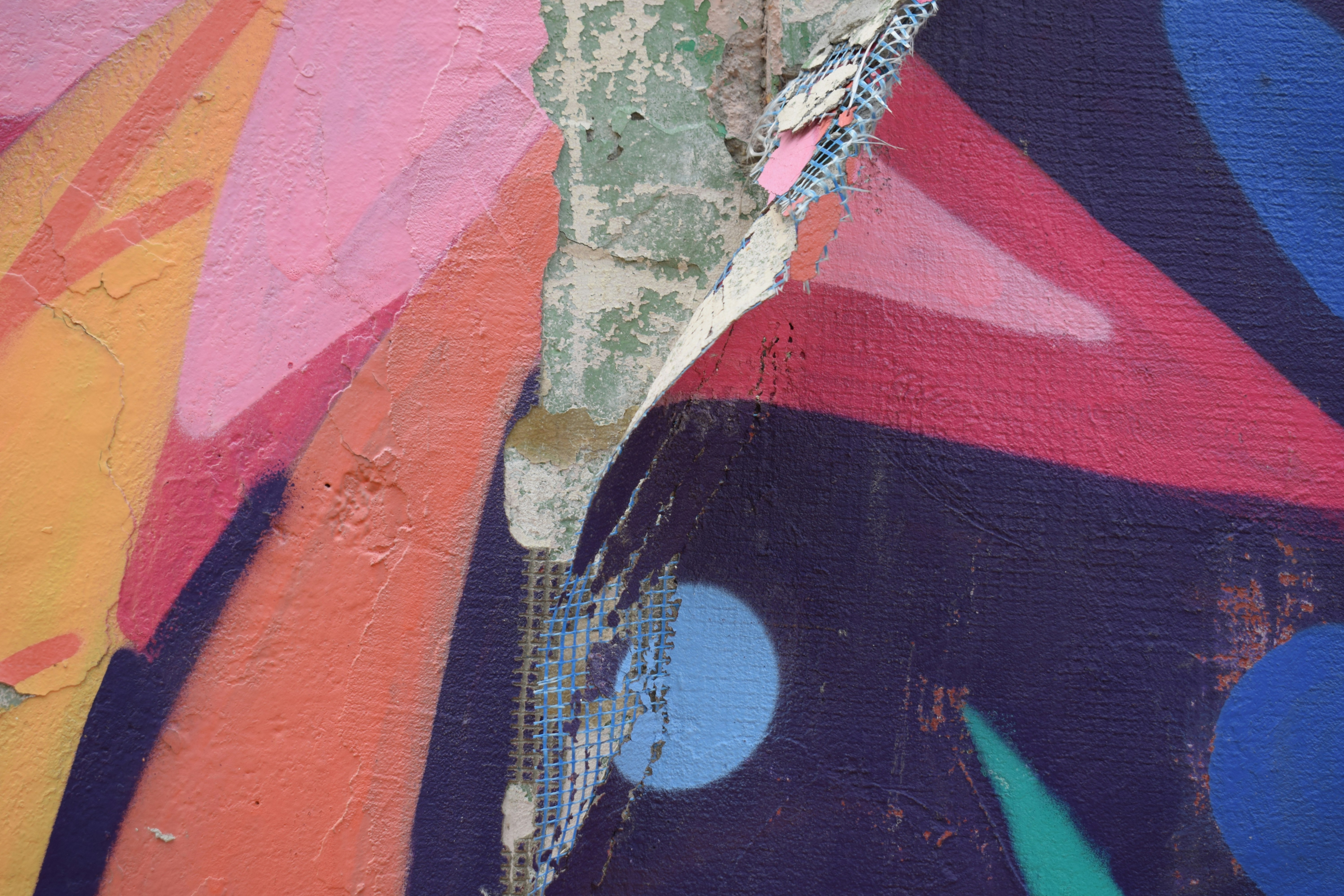 Fragmented Color Play on Painted Wall with Weathered Edges