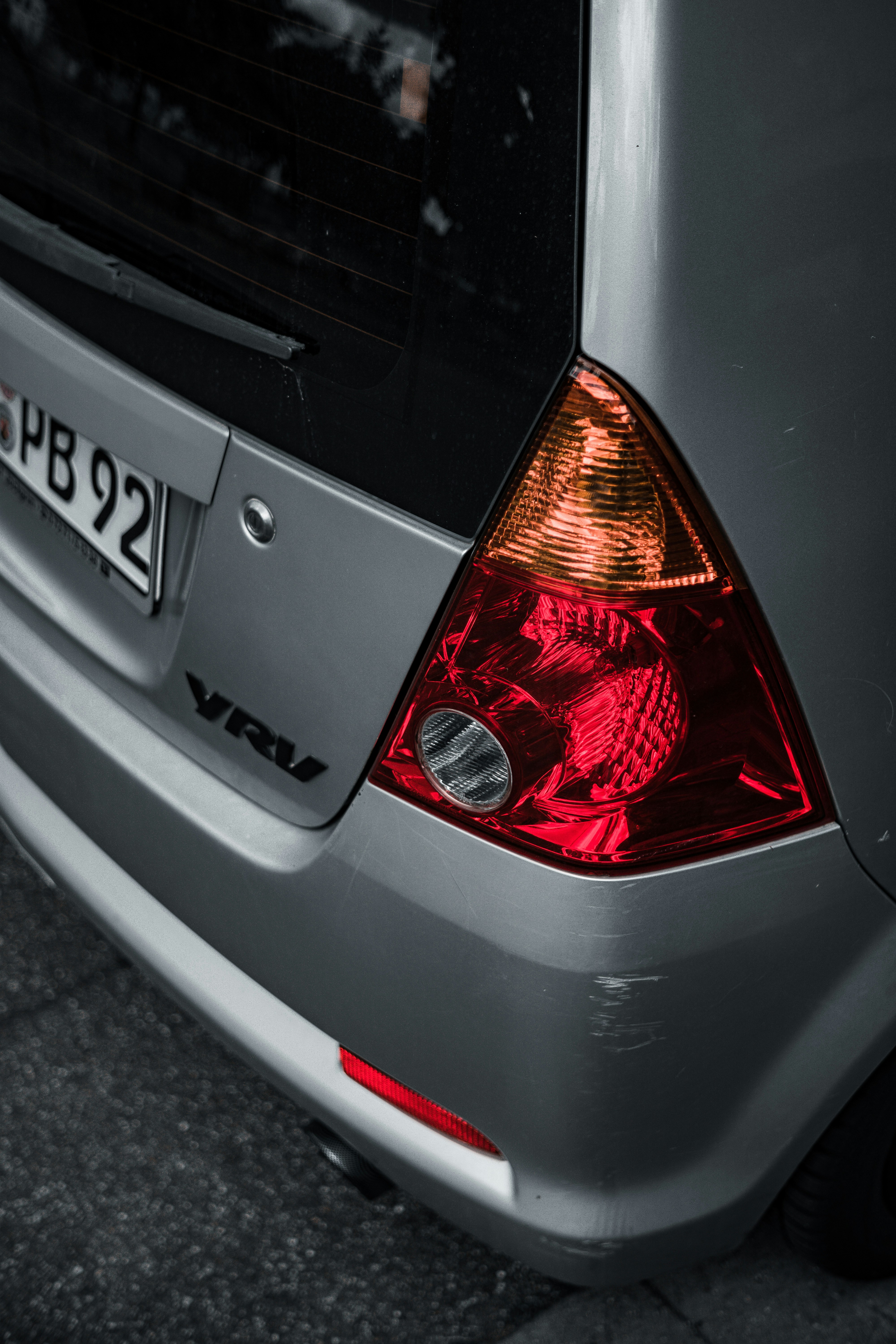 Tail-Light Geometry in Silver: A Close-Up of a Weathered Hatchback