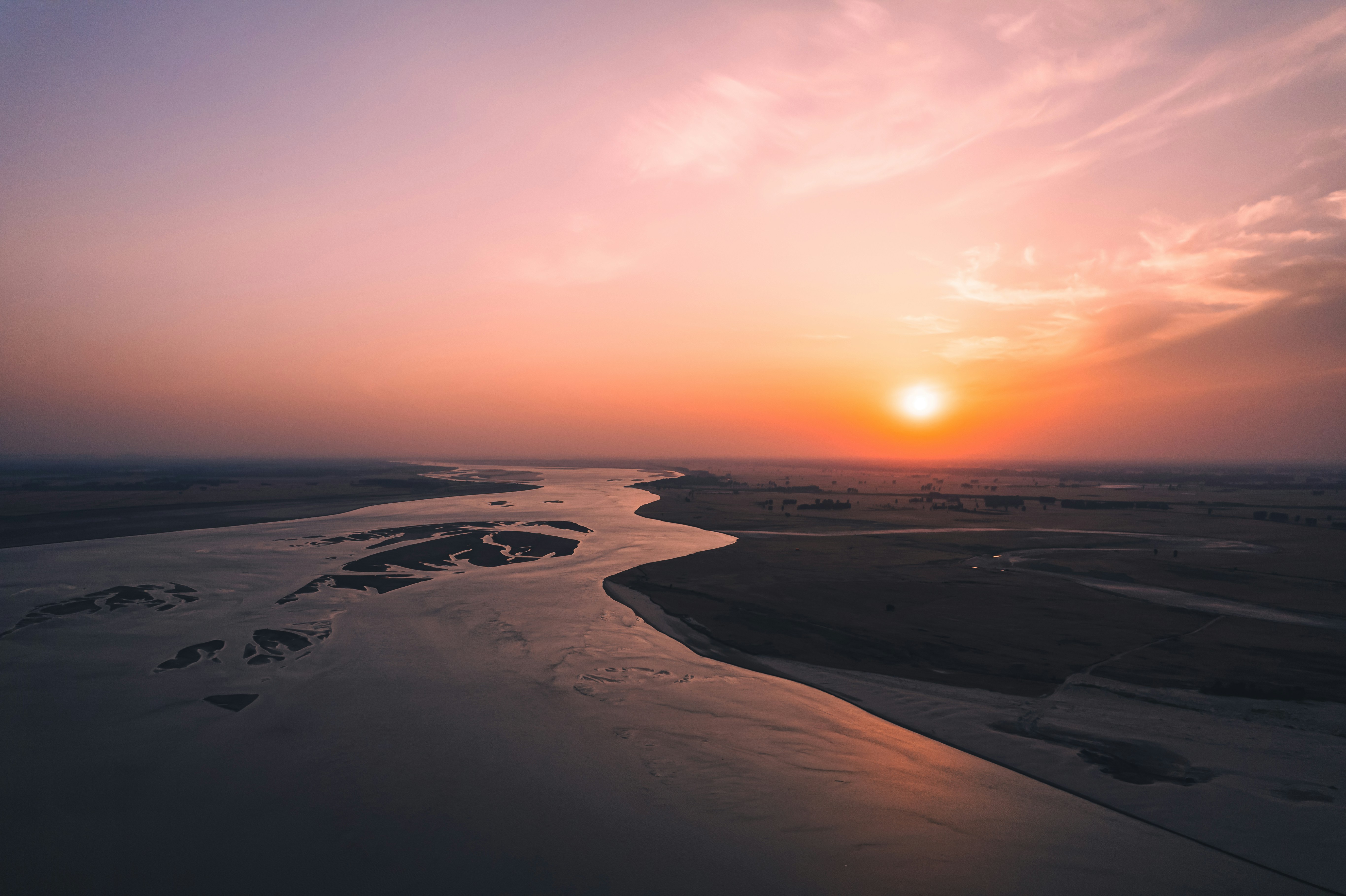 Low-Altitude Confluence: Sunset Over a Meandering River Delta
