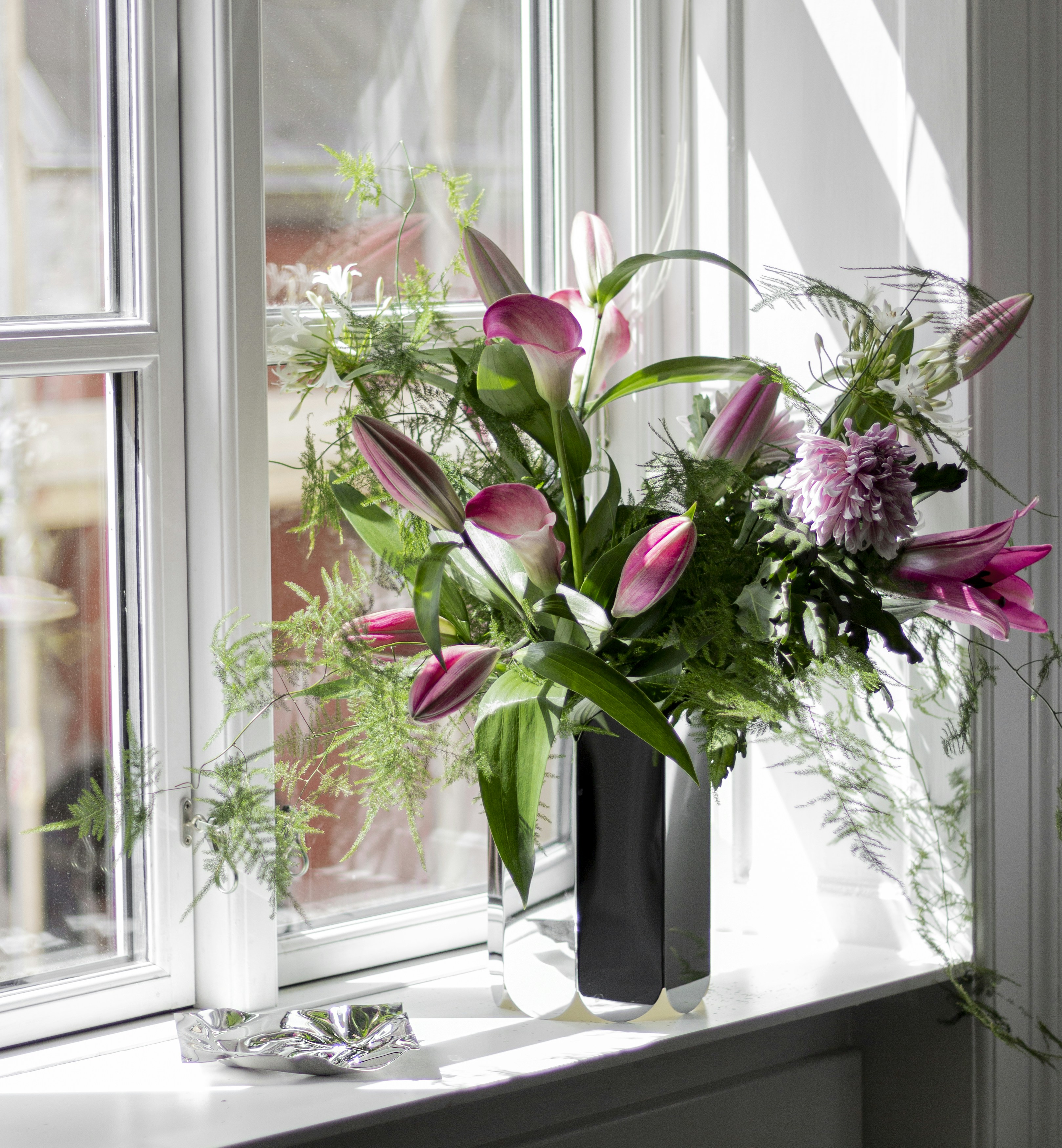Morning Light Paints Pink Lilies in a Glass Vase on the Windowsill