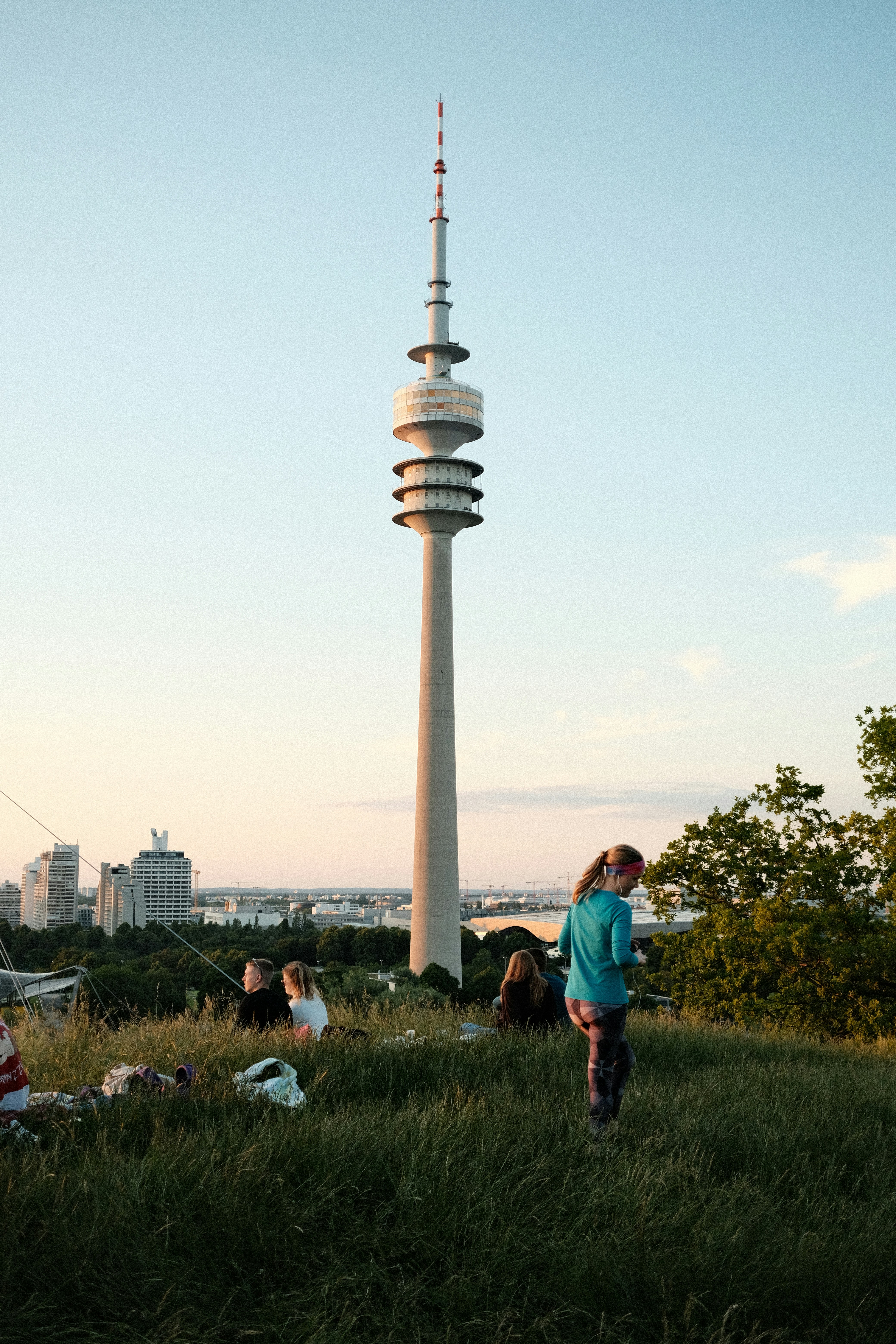 a tall tower in a park with Olympiaturm in the background