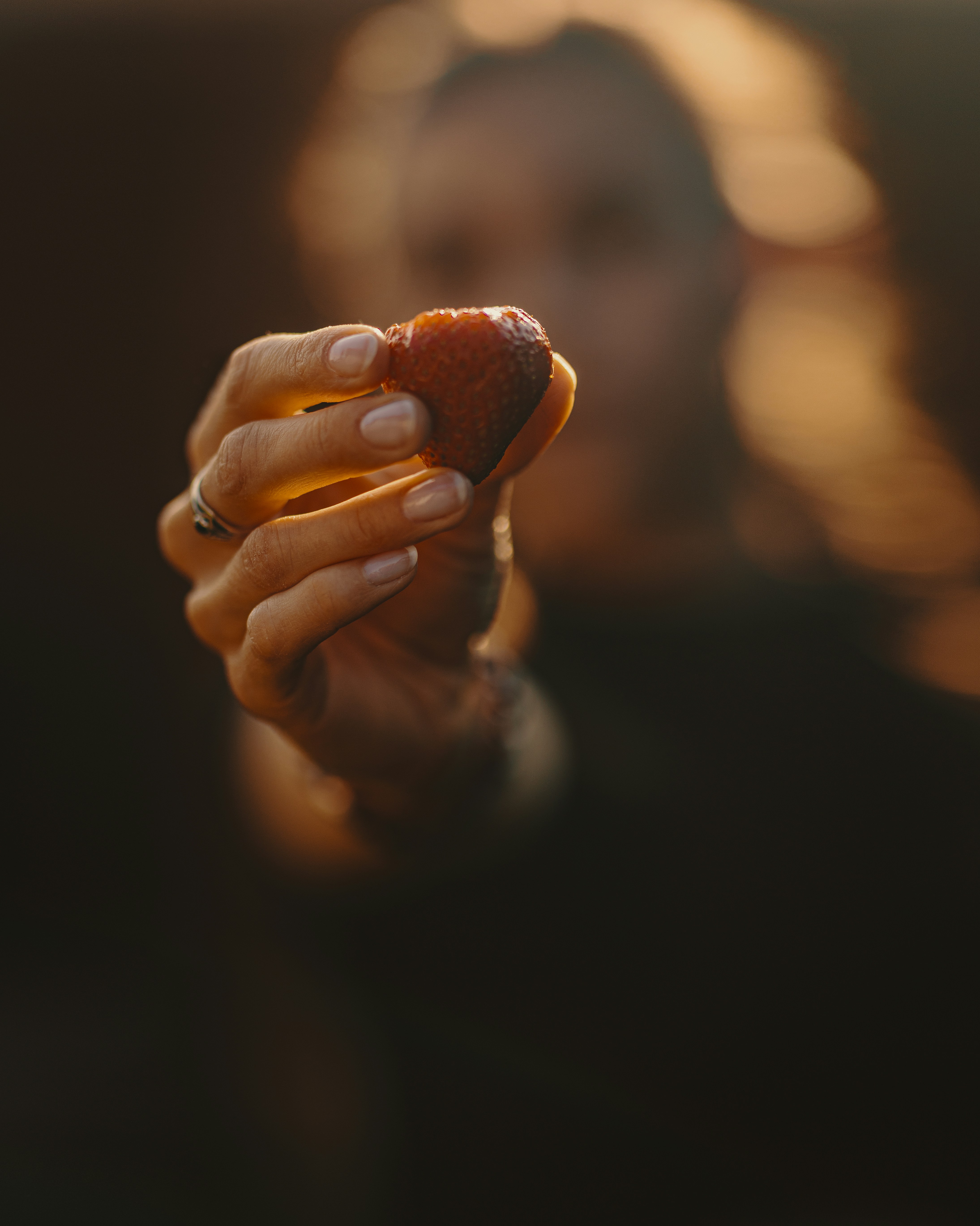 Strawberry in Soft Sunset: A Close-Up Held Toward the Warm Backlight