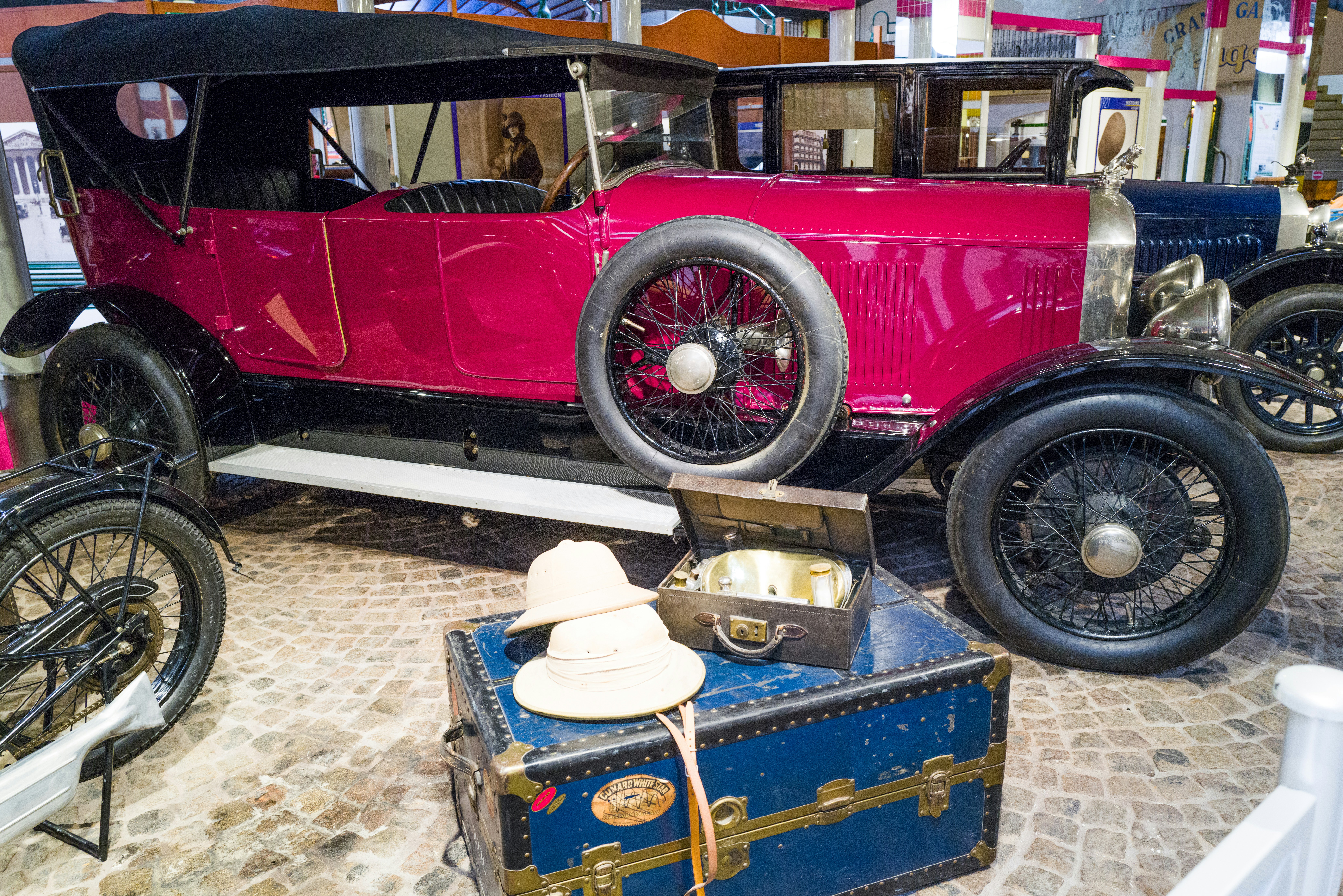 Royal Red: A Vintage Car Ensemble in a Cobblestone Courtyard