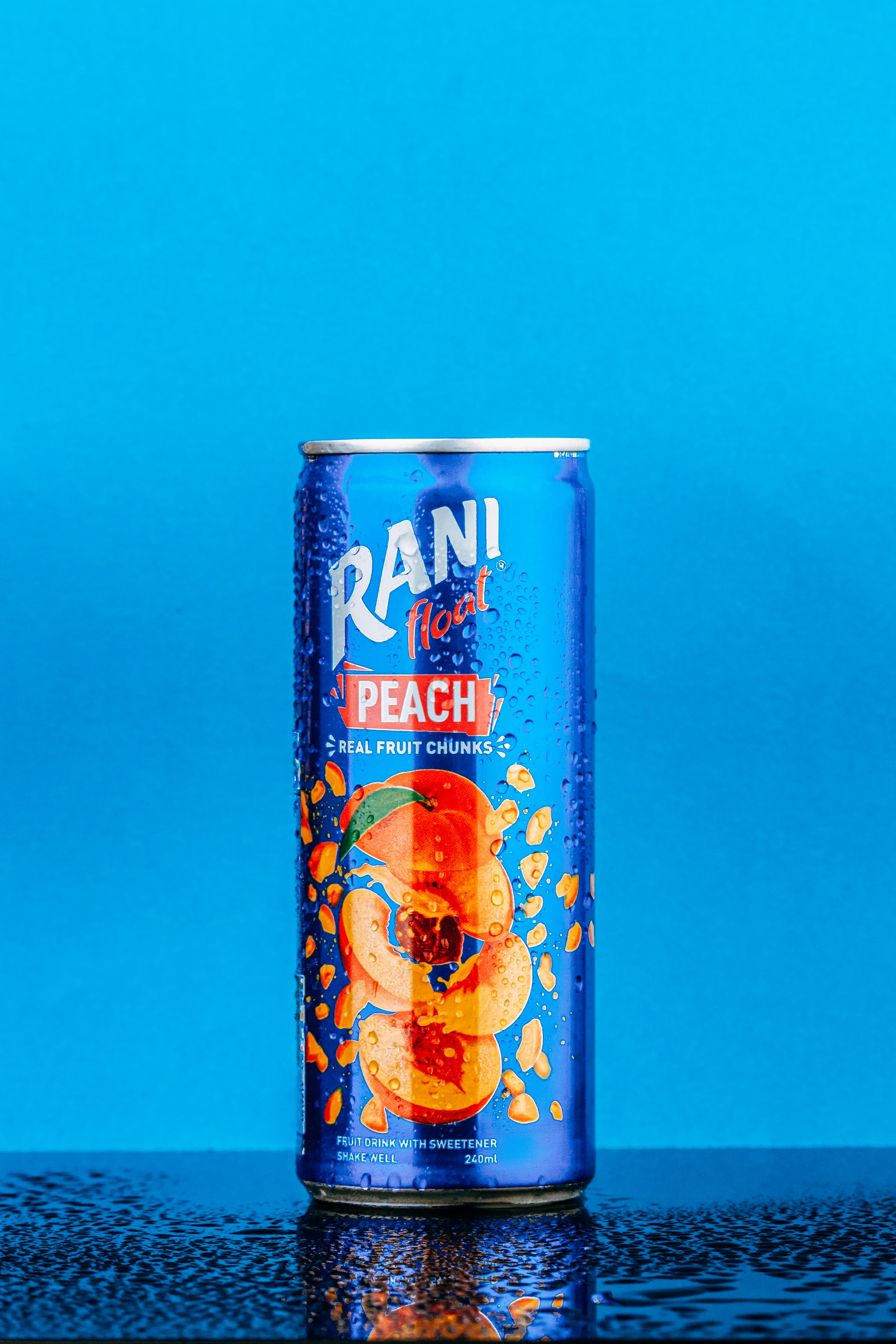 Peach-Quenched Geometry: A Dew-Dusted RANI Can on Electric Blue