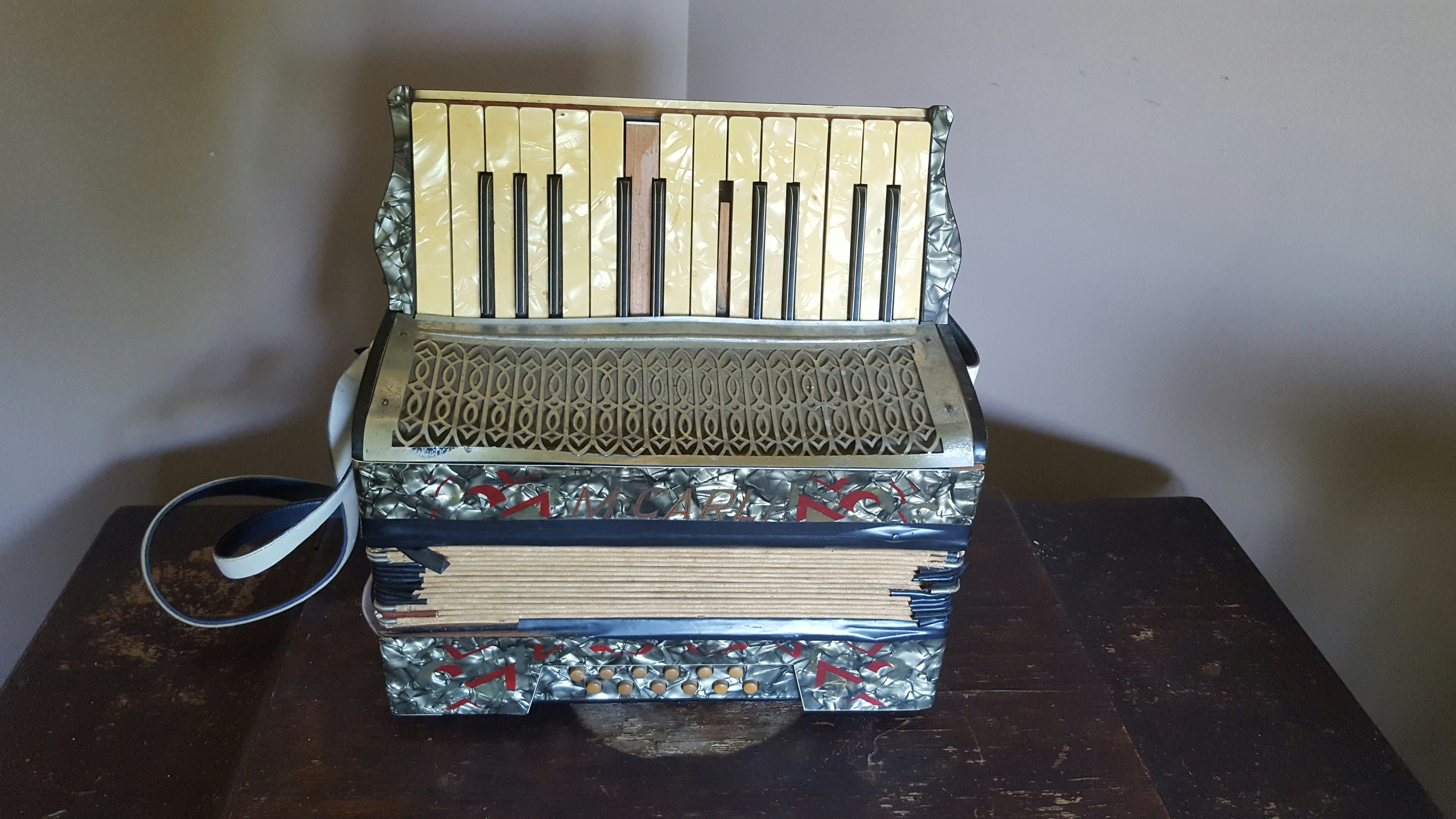 Echoes of Silver: A Vintage Accordion Resting on a Wooden Table