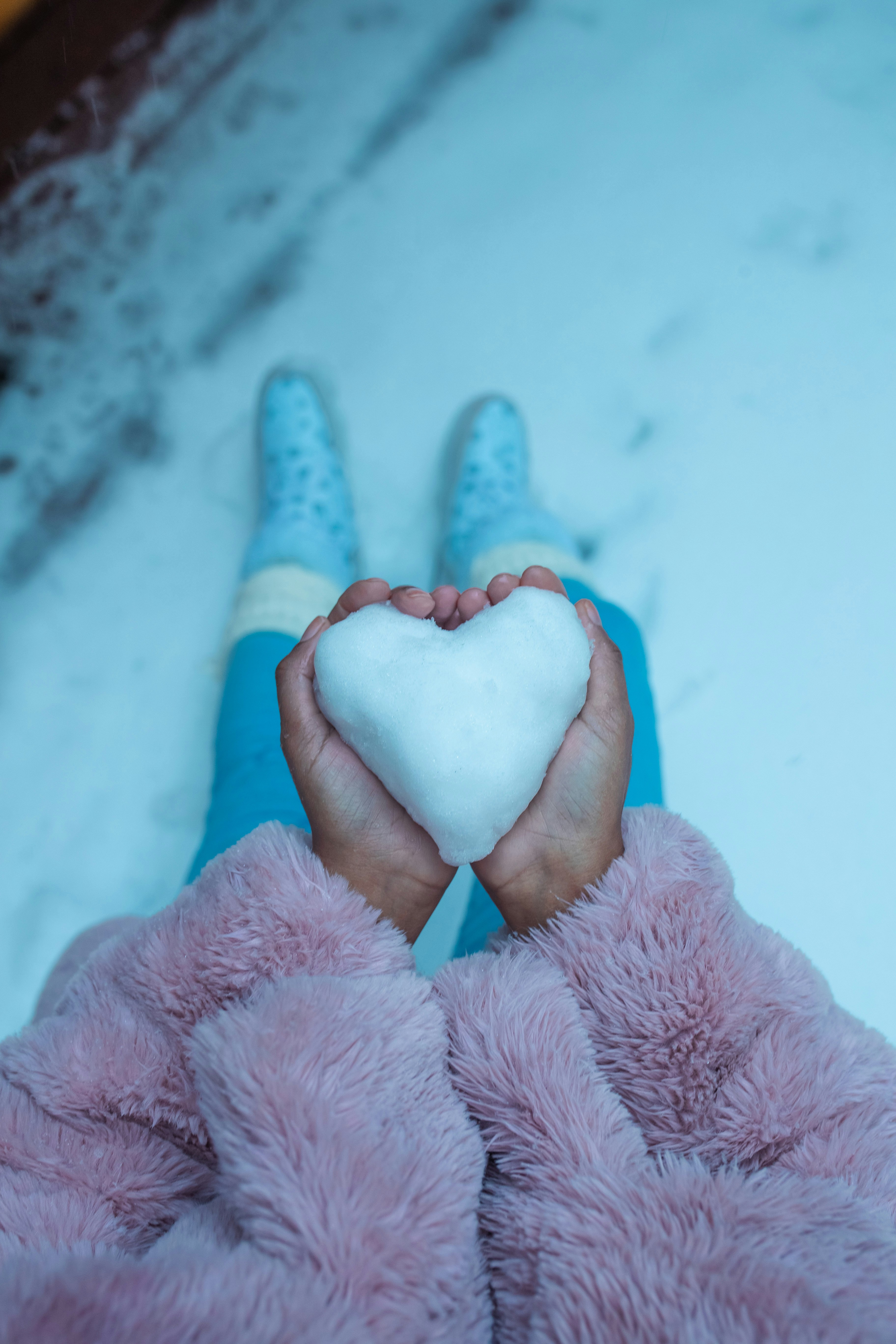 Cradled Snow Heart: A Winter Moment in Pink and Blue