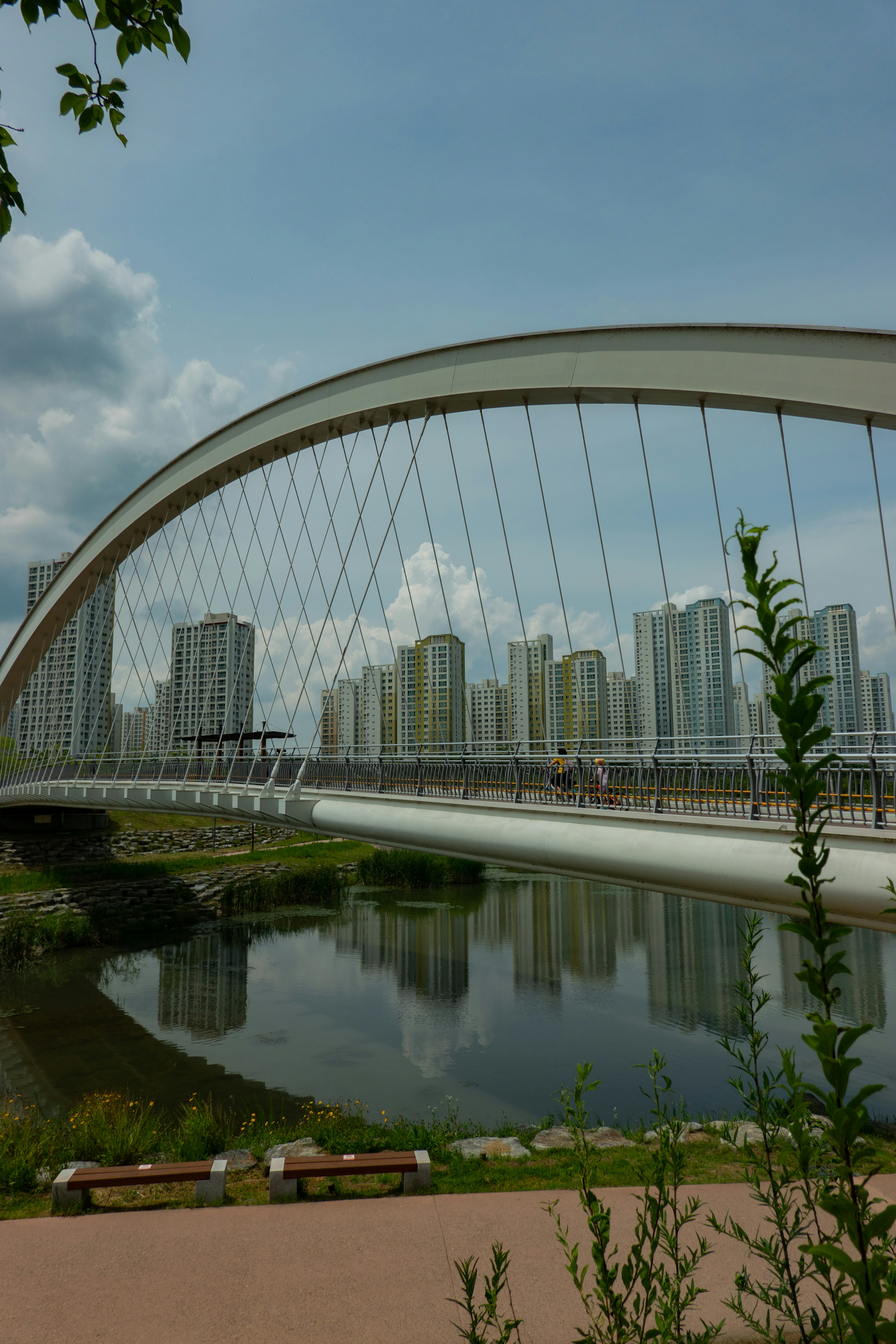 a bridge over a river with a city in the background