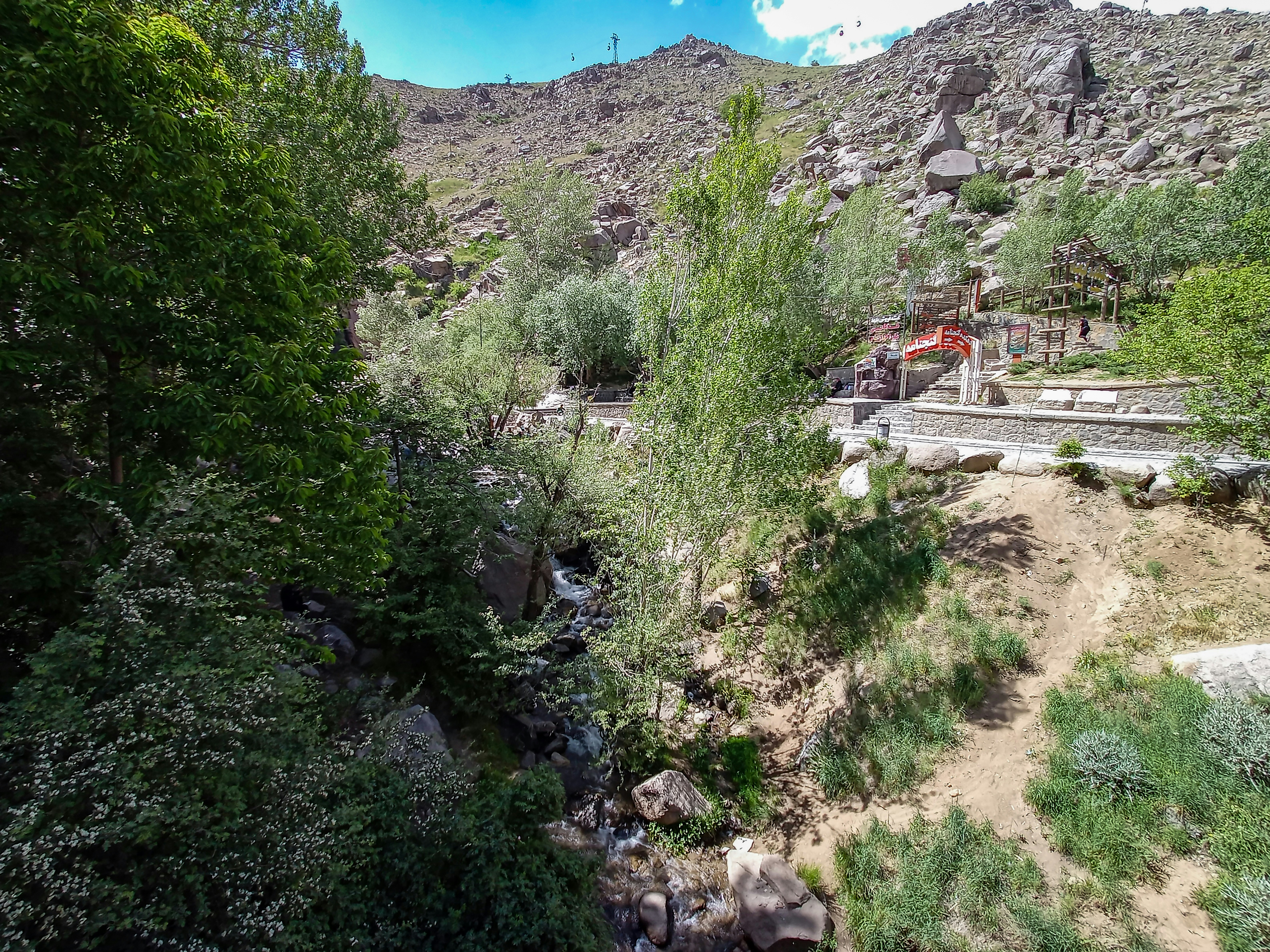 Rugged Riverside Overlook: sunlit path between granite slopes