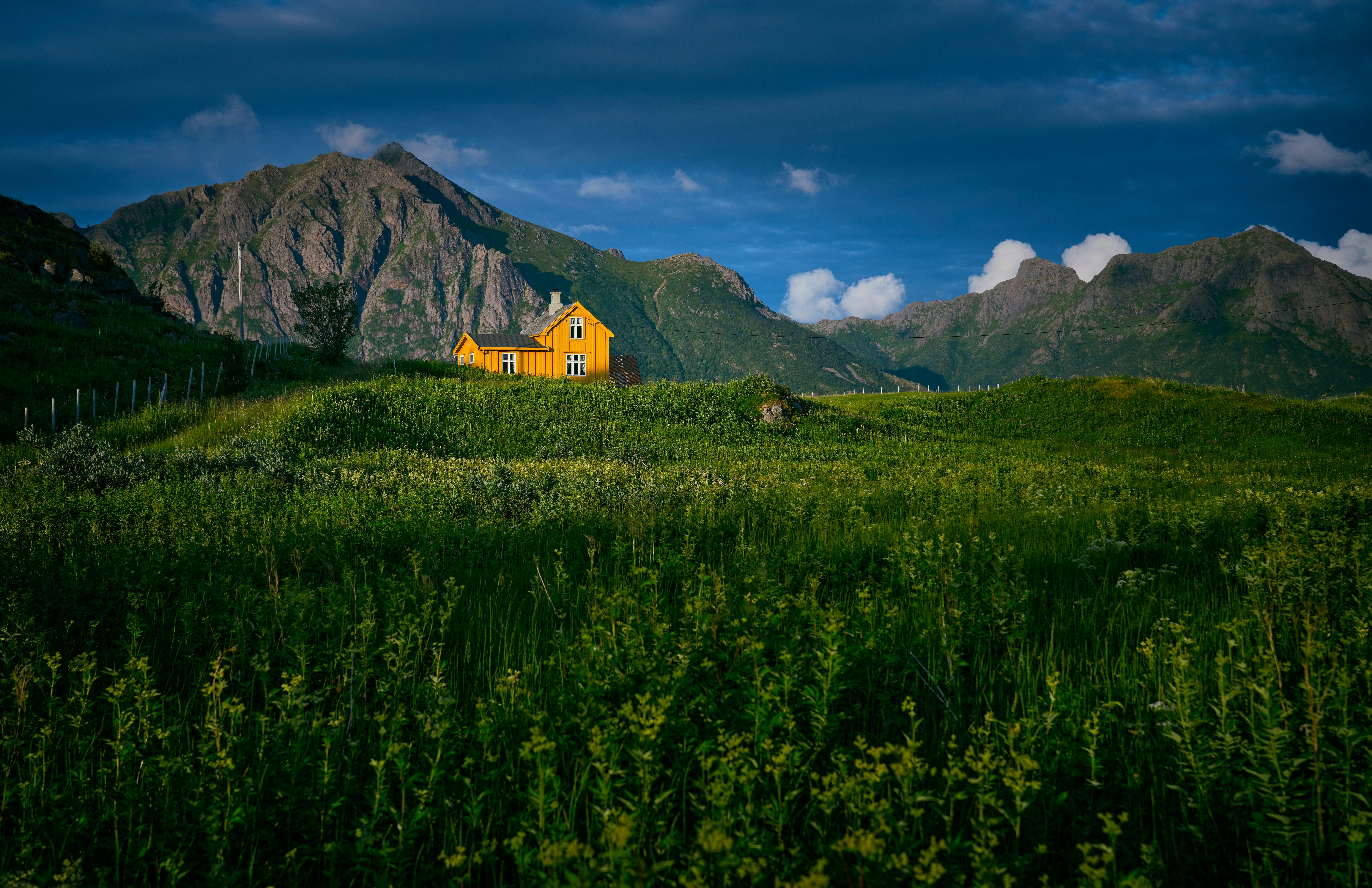 Amber Cottage Amid Verdant Valleys and Rugged Peaks