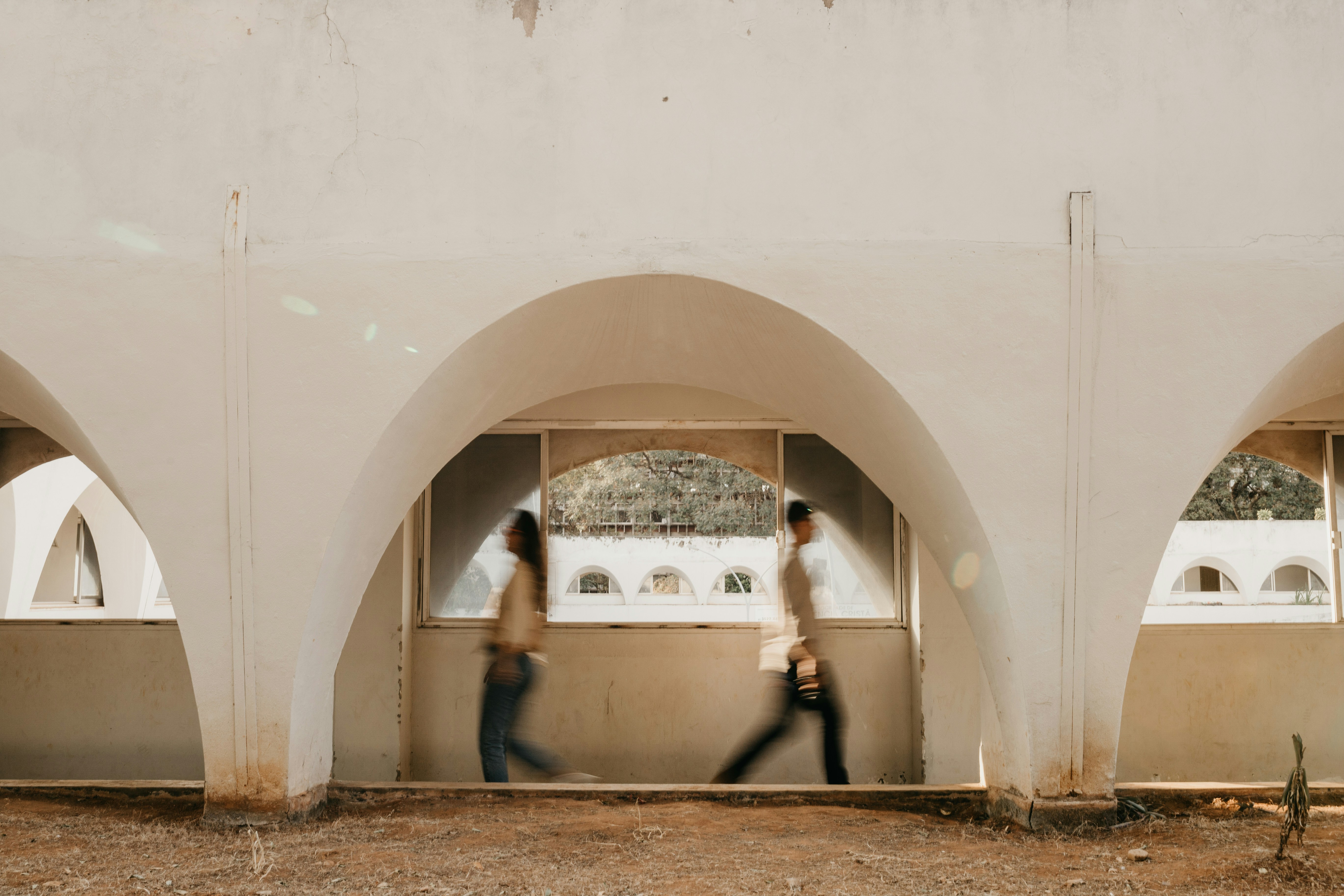 A couple of people walking through a building photo – Free City Image ...