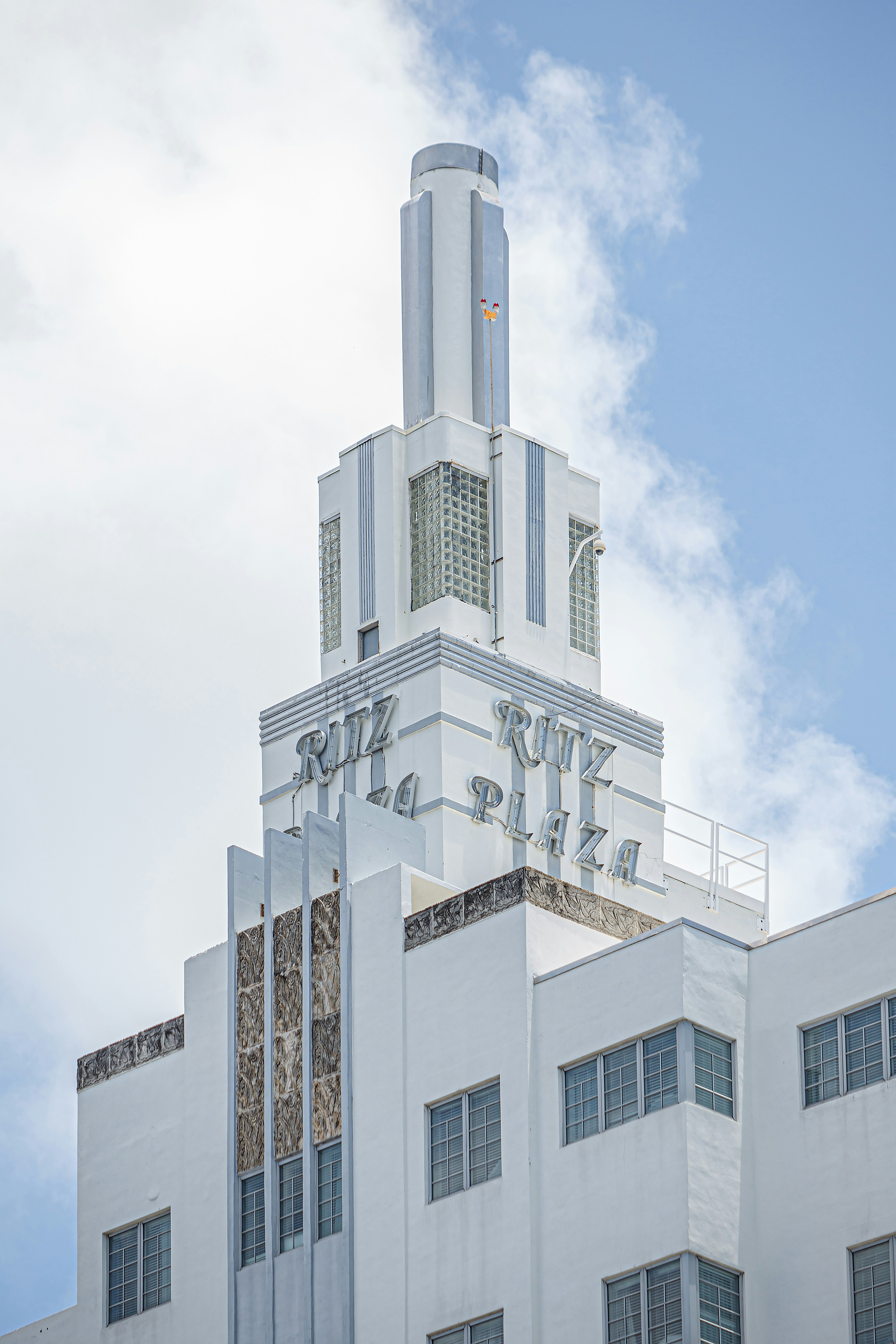 Art Deco tower of Ritz Plaza Hotel against a blue sky.