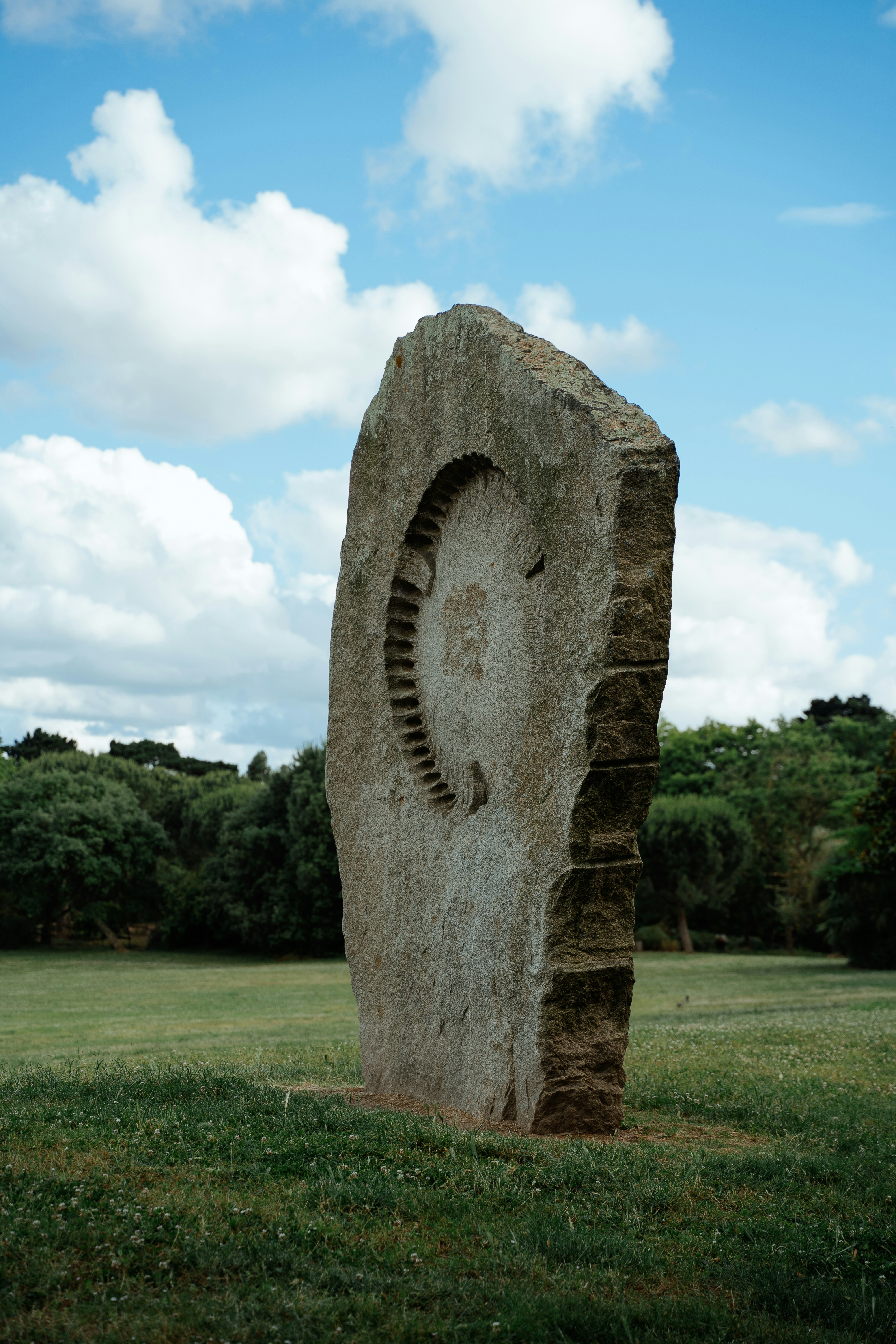 The Gear-etched Monolith: A Stone Sentinel in the Meadow