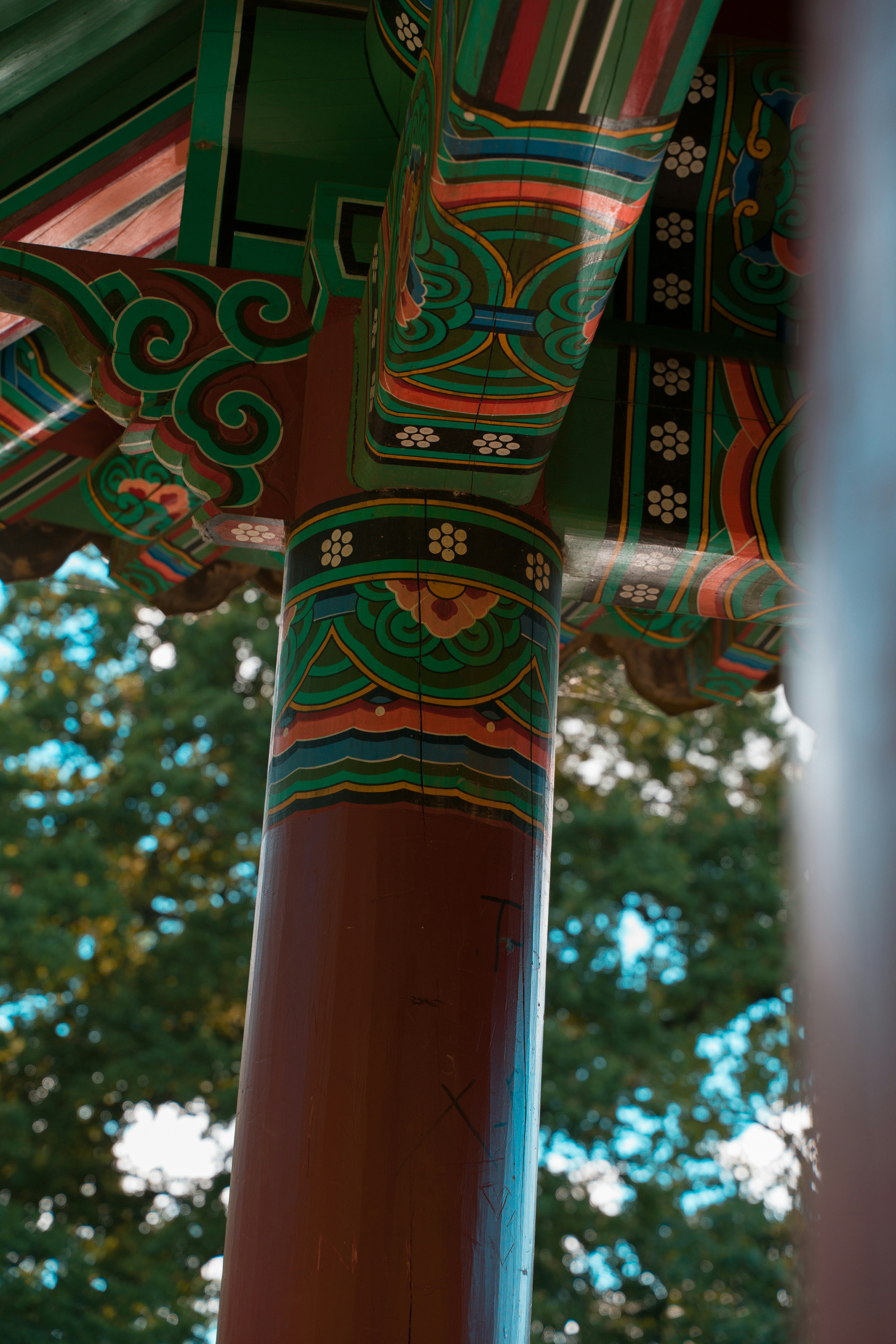 Kaleidoscope Pillar: A Temple Column Wrapped in Green, Red, and Gold