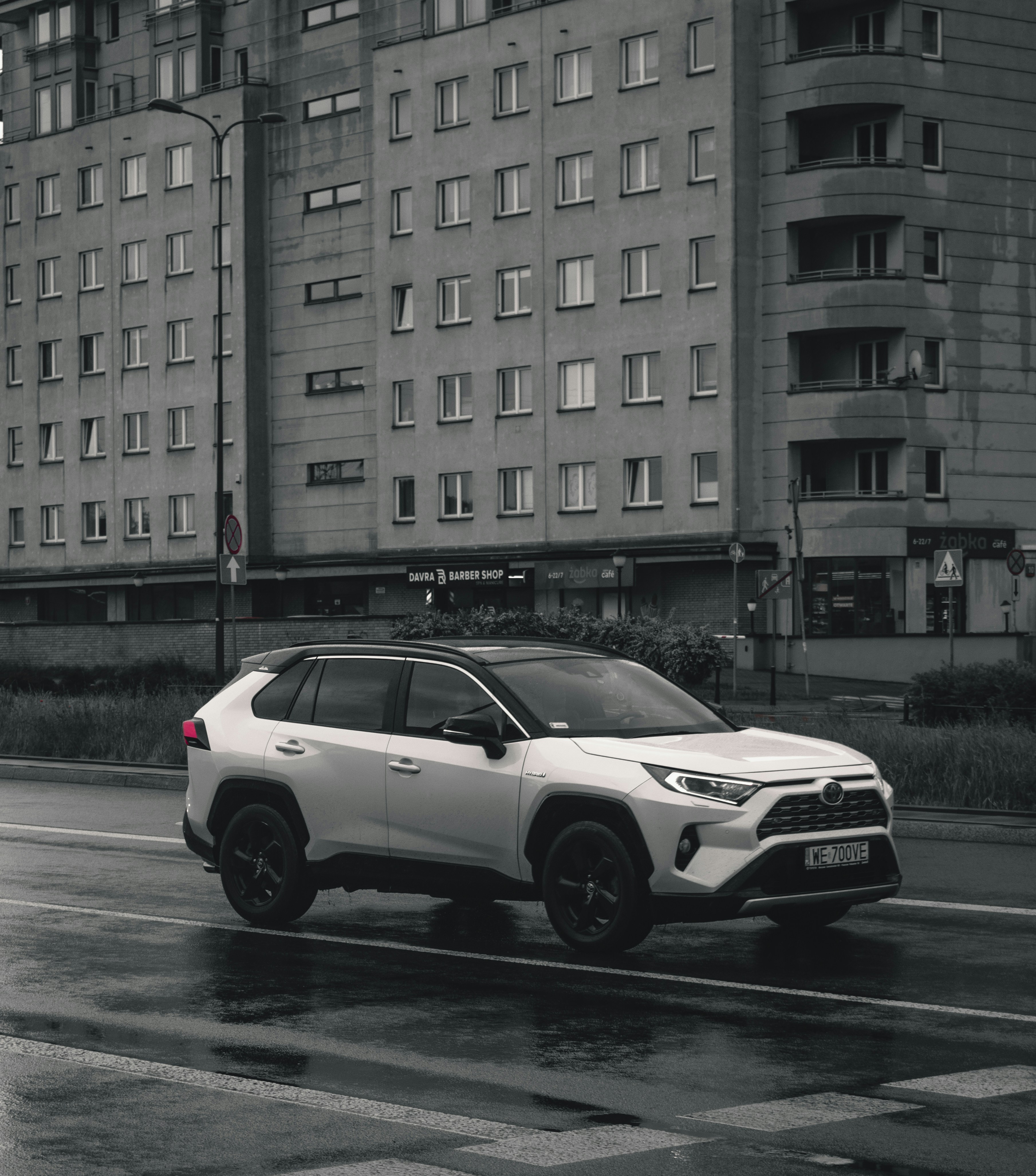 a white car parked in front of a building