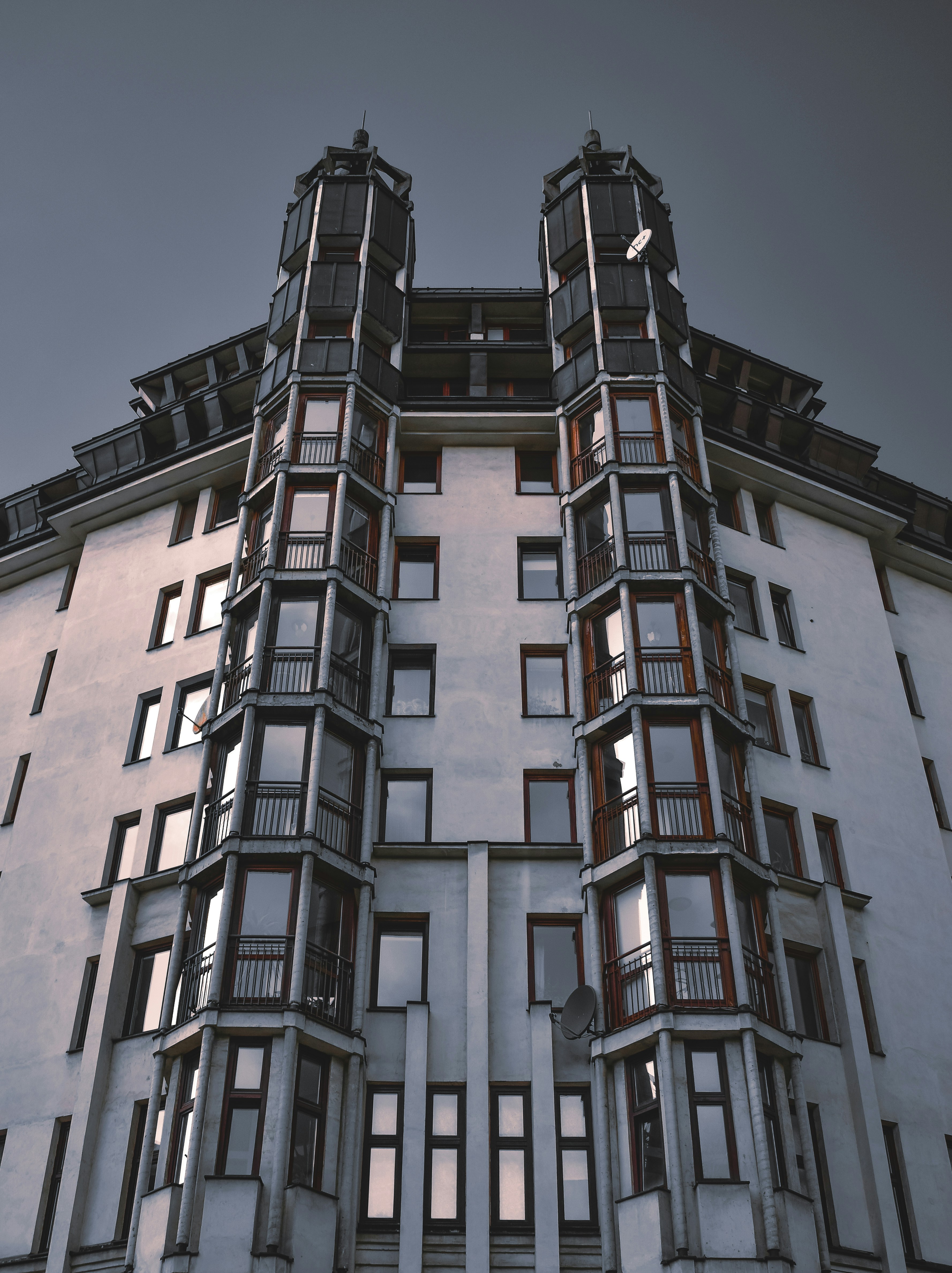Unique architectural design featuring prominent balconies and large windows on a contemporary building facade.