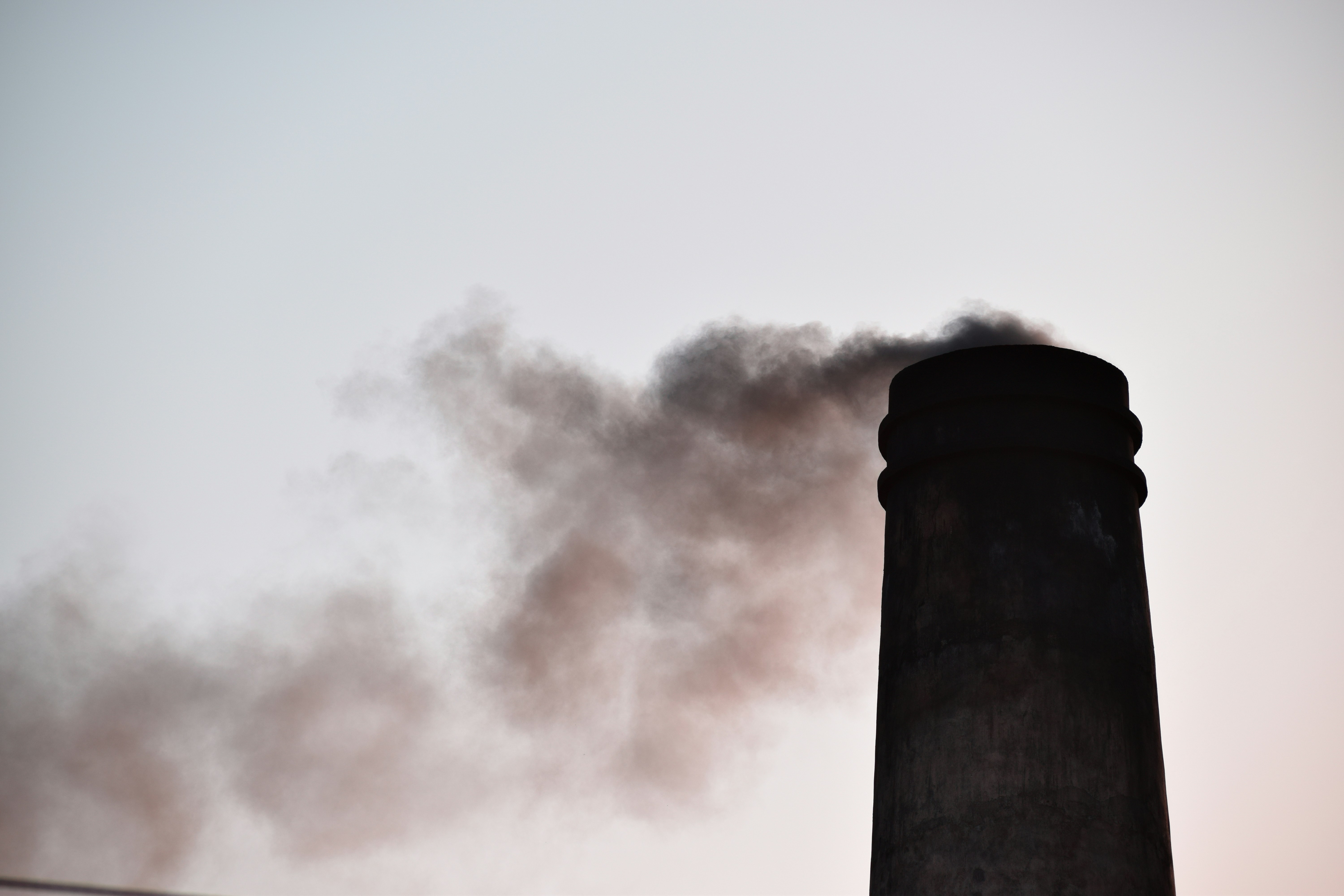 A tall chimney with smoke coming out of it photo – Free Chimeny Image ...