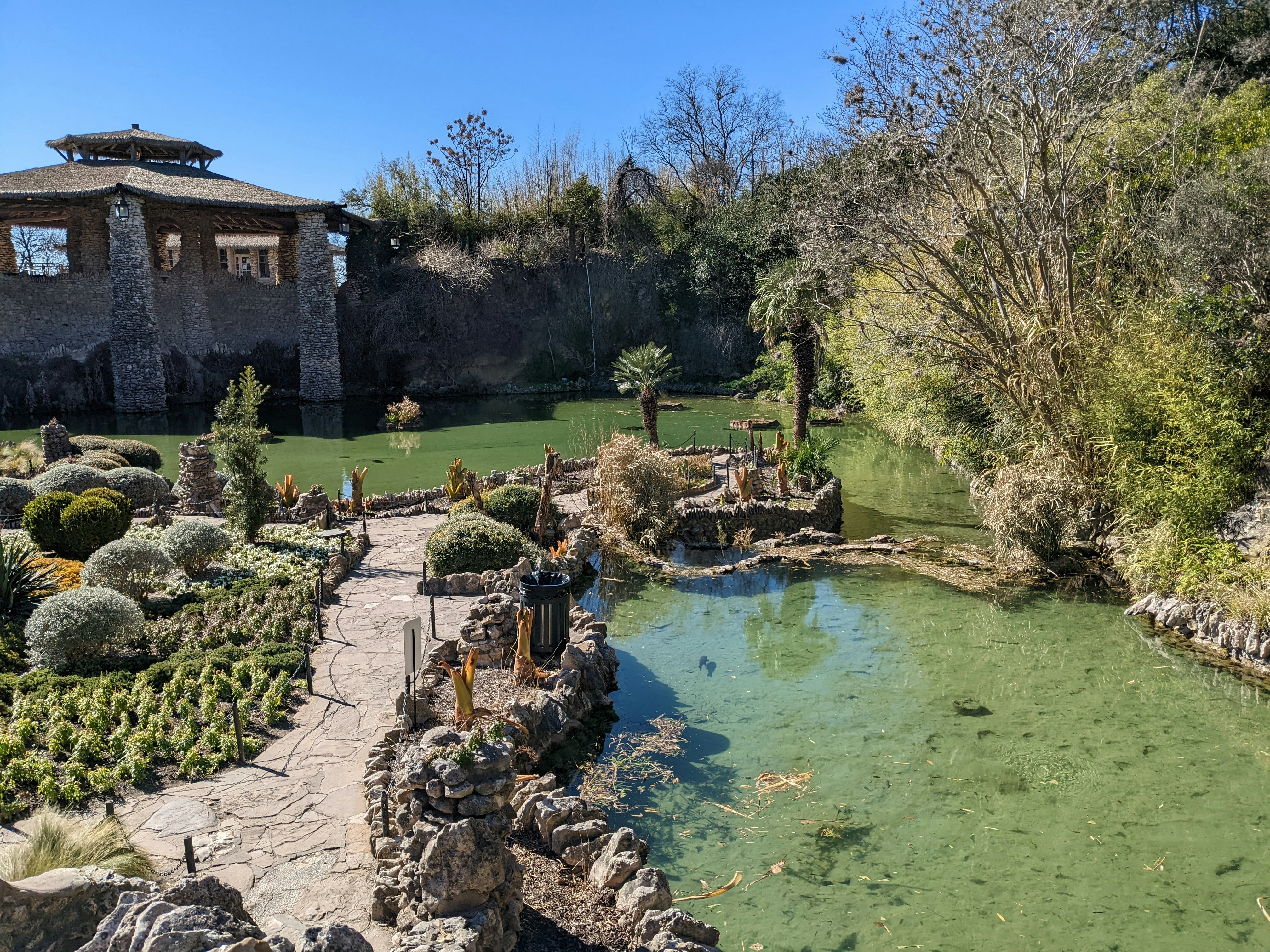 Stonewalks and a Verdant Pond: A Sunlit Garden's Quiet Center