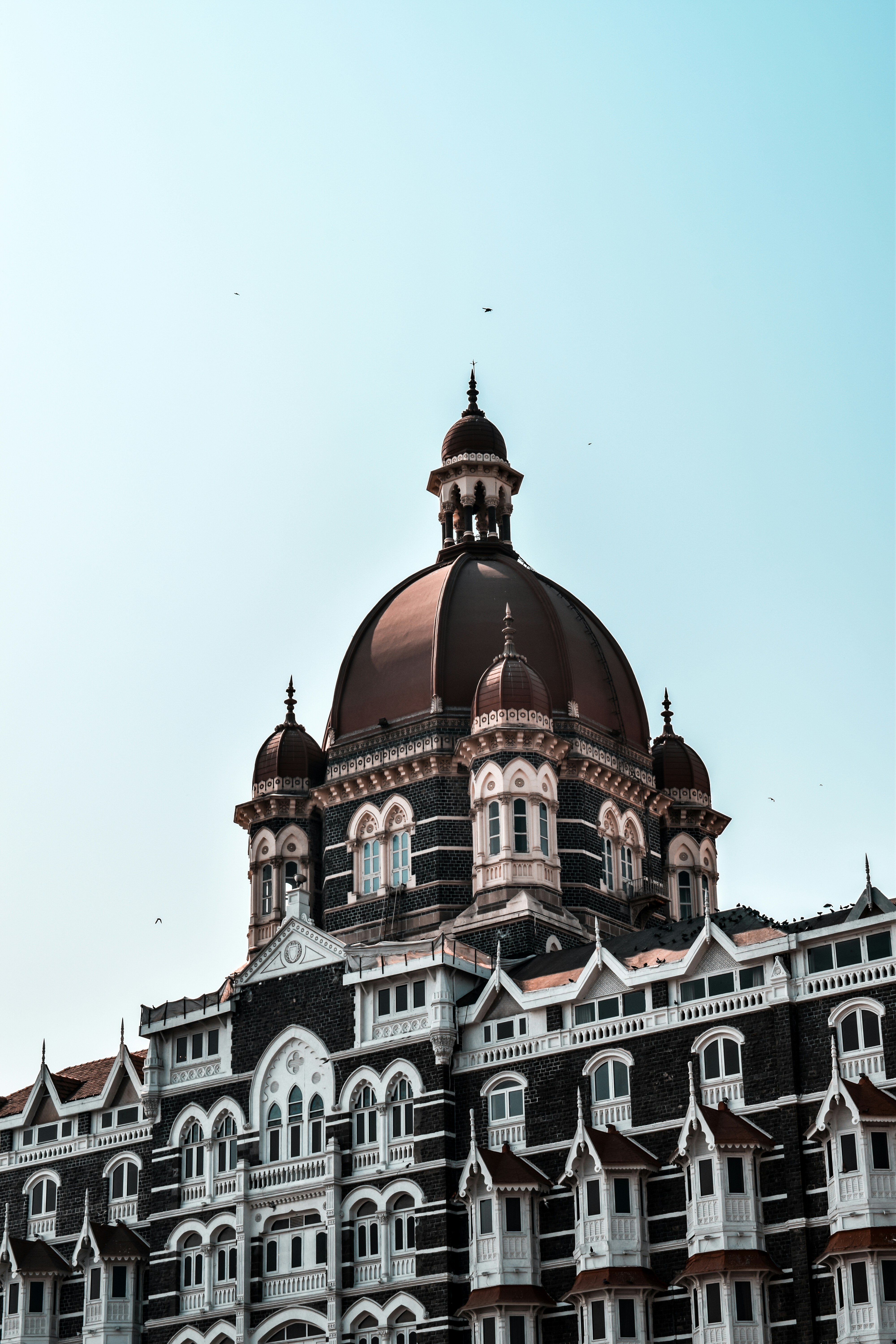 Historic building with a prominent dome and intricate façade details, showcasing classic architectural design against a clear sky.
