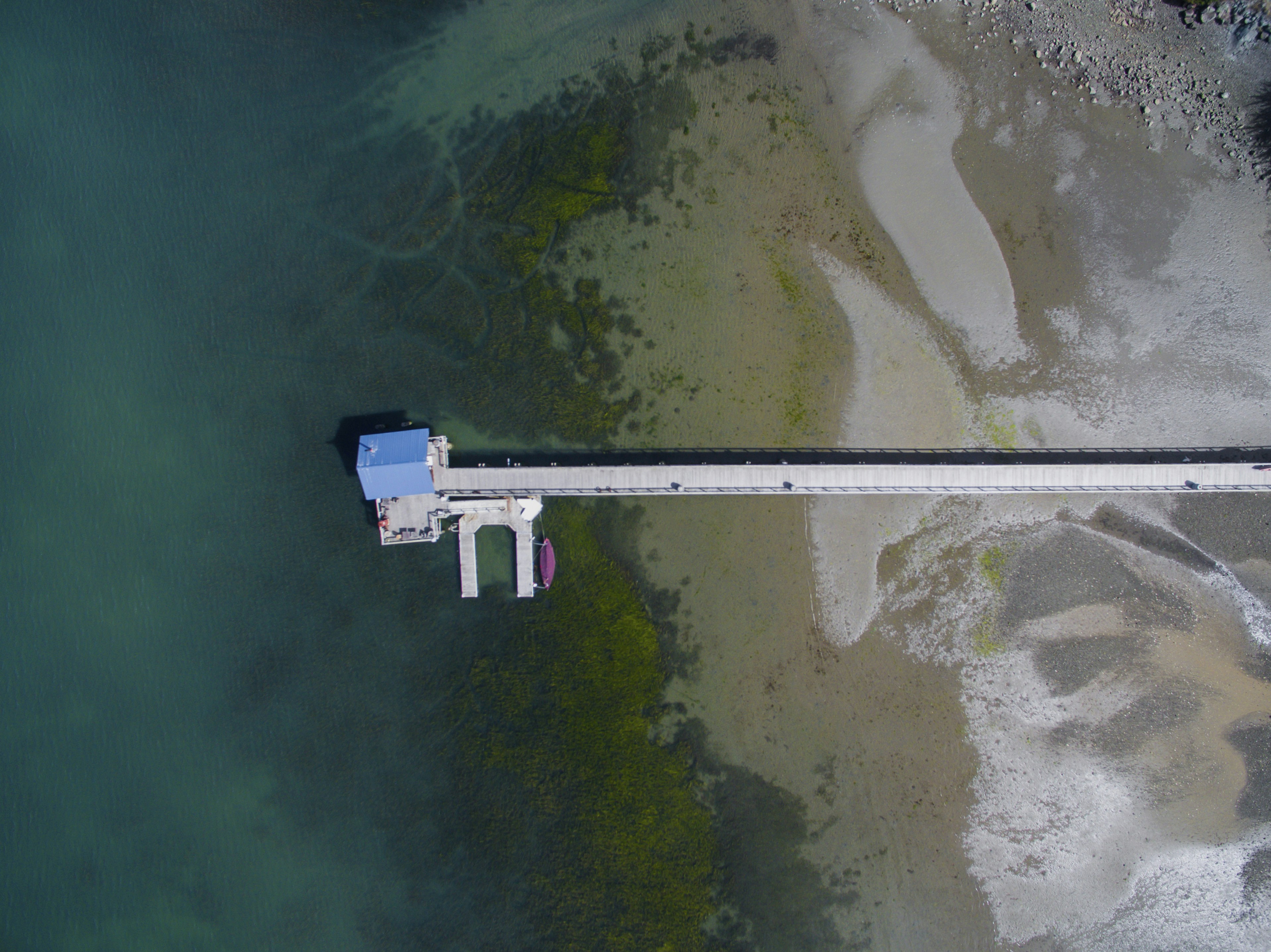 Blue-Roof Pier at the Edge of Turquoise Seas