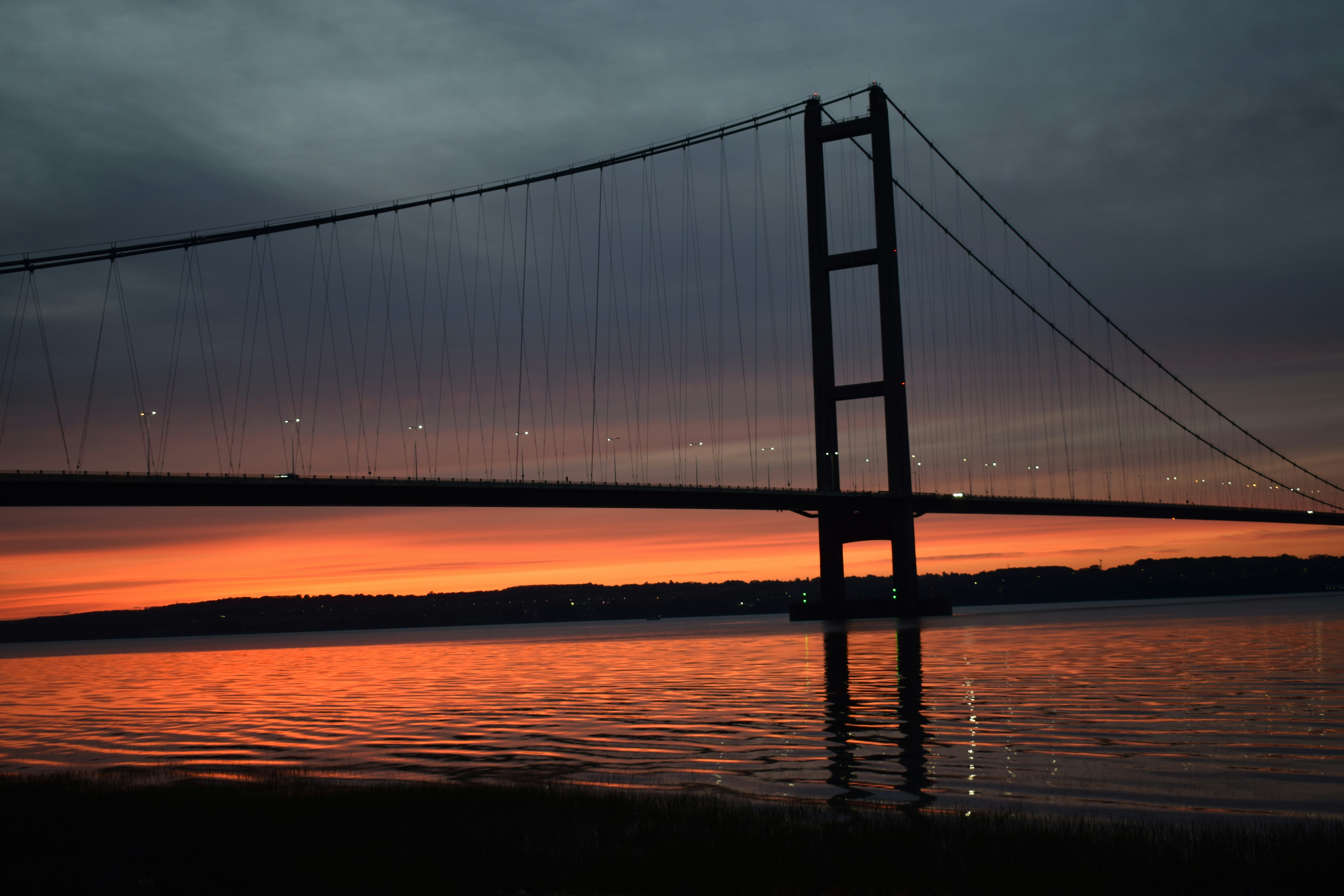 Ember Span at Dusk: A Suspension Bridge Framed by a Golden Horizon