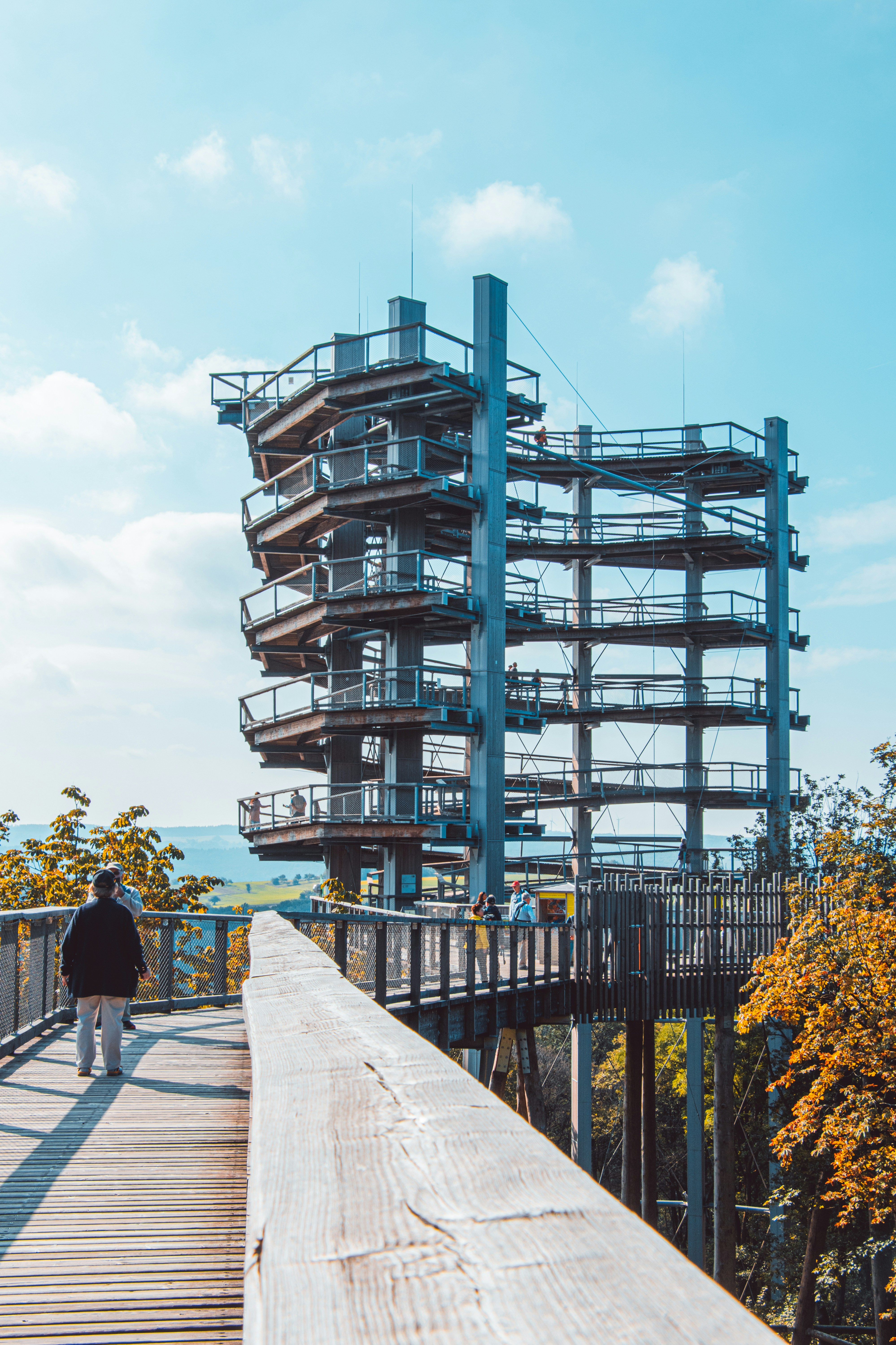 Cylindrical Stair Tower Rising Over a Wooden Skywalk