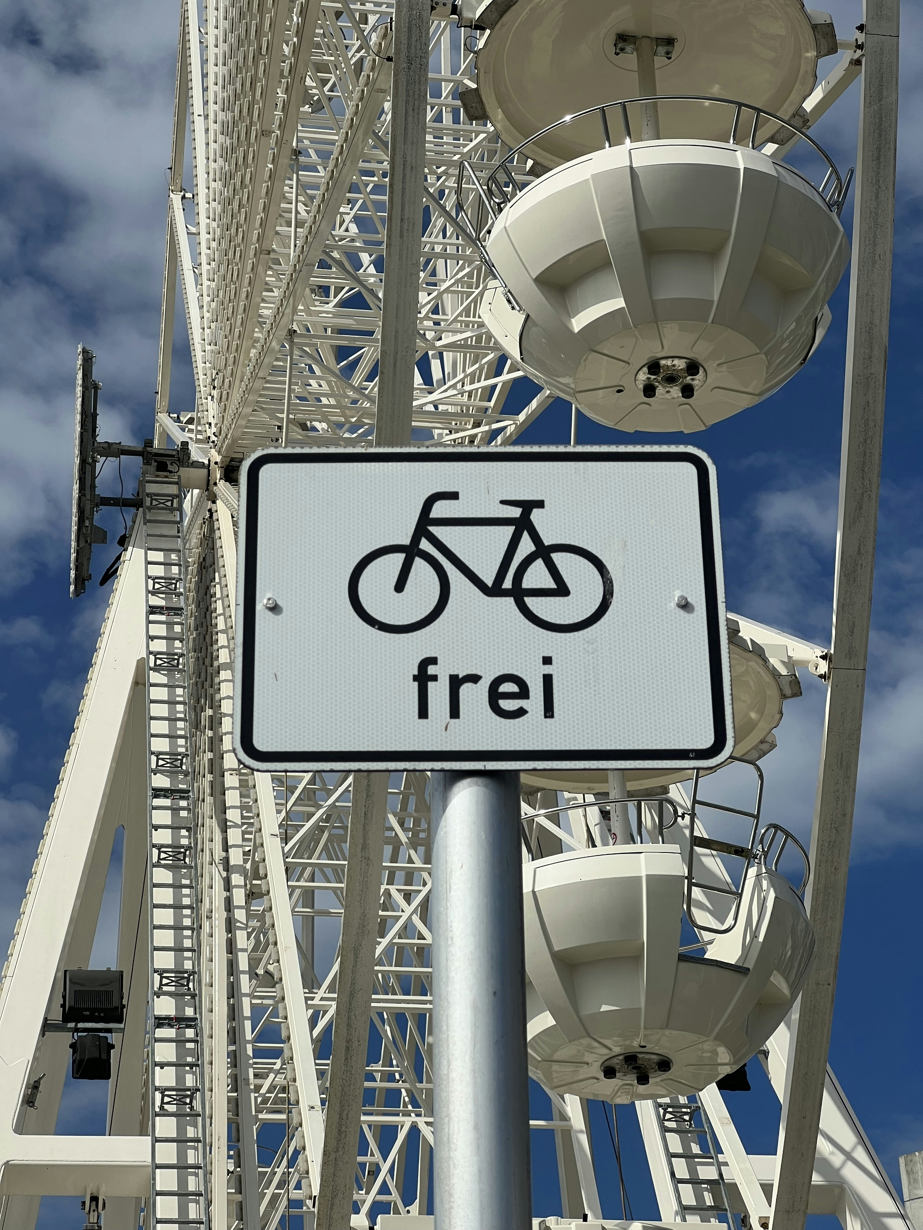 Frei Bicycle Sign Framed by a Ferris Wheel