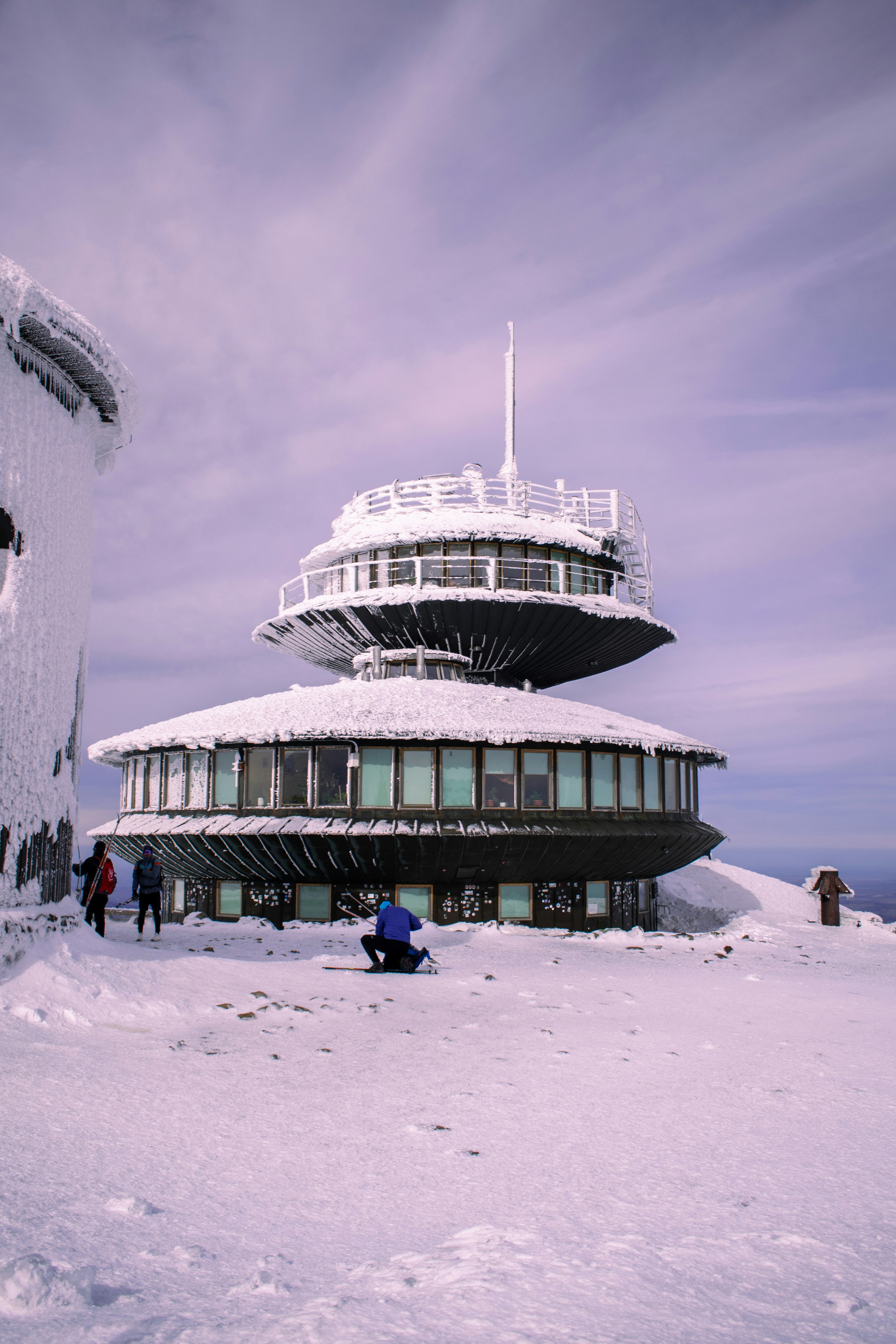 A building with a tower in the snow photo – Free Sněžka Image on Unsplash
